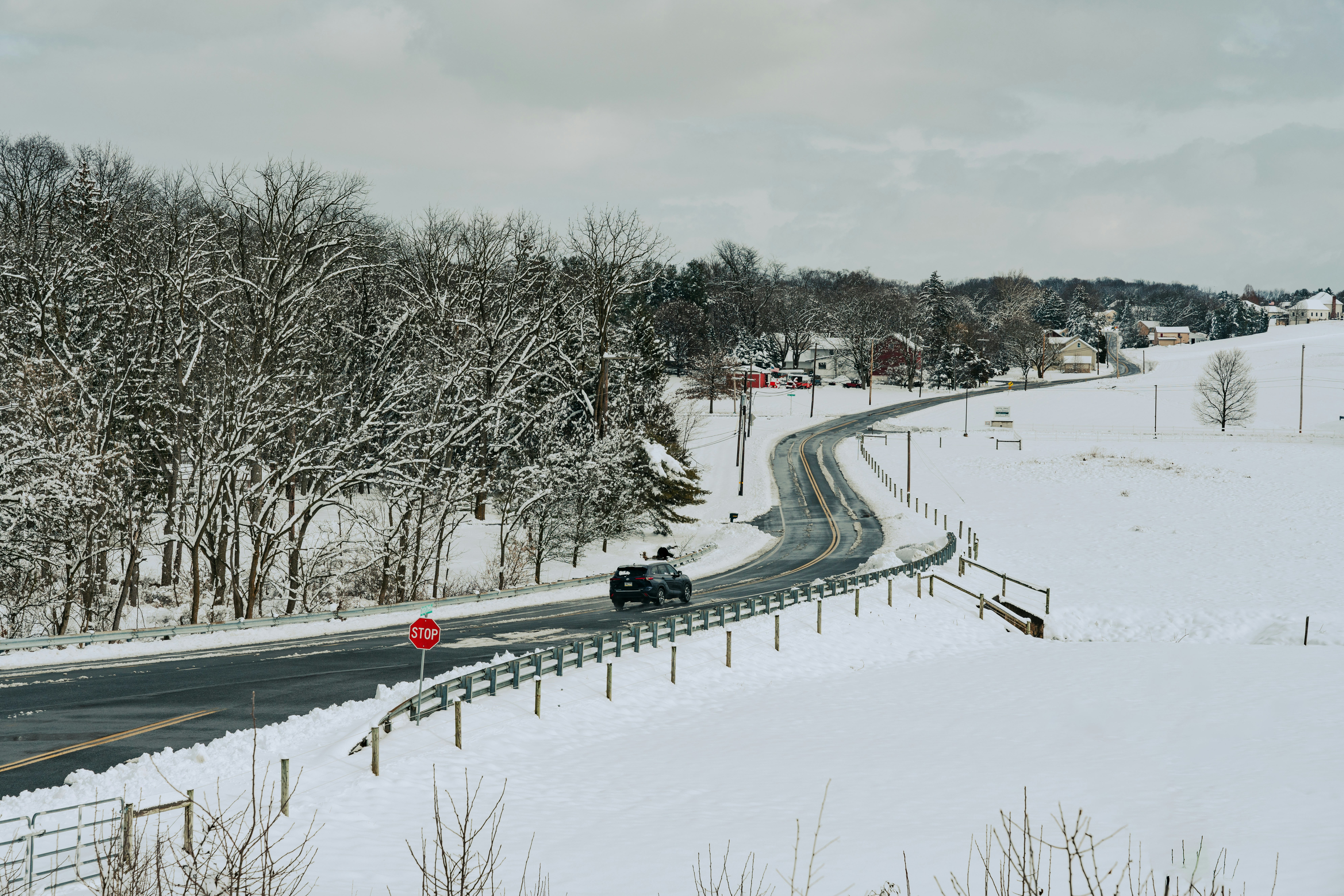 a car driving down a snow covered road