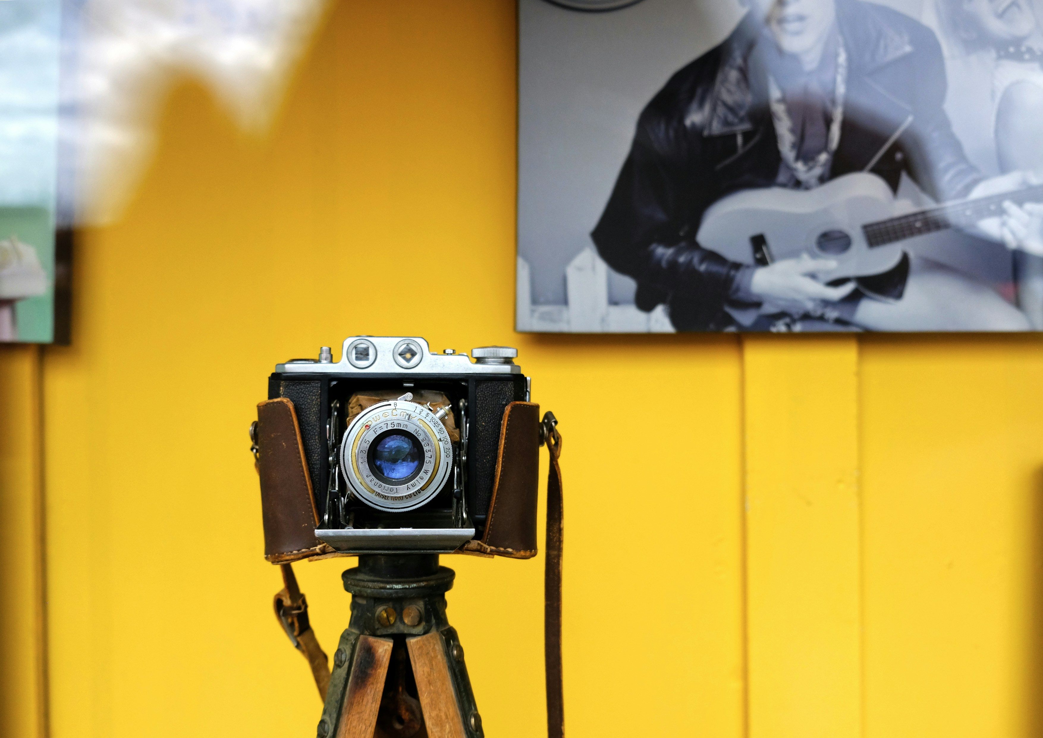 Antique Lens on a Yellow Stage: Quiet Precision Against a Bright Backdrop