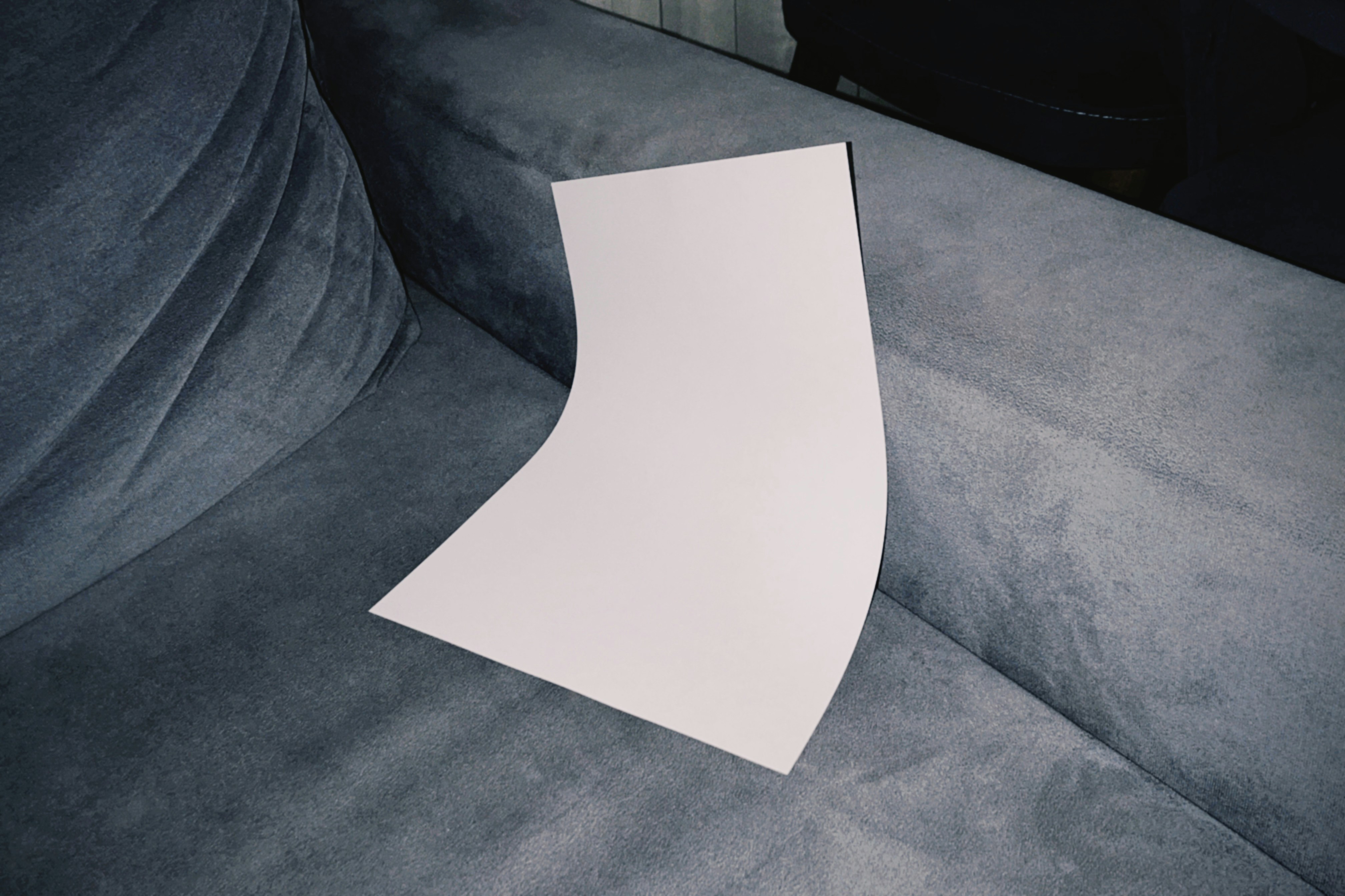 White Paper, Quiet Geometry on a Velvet Blue Sofa