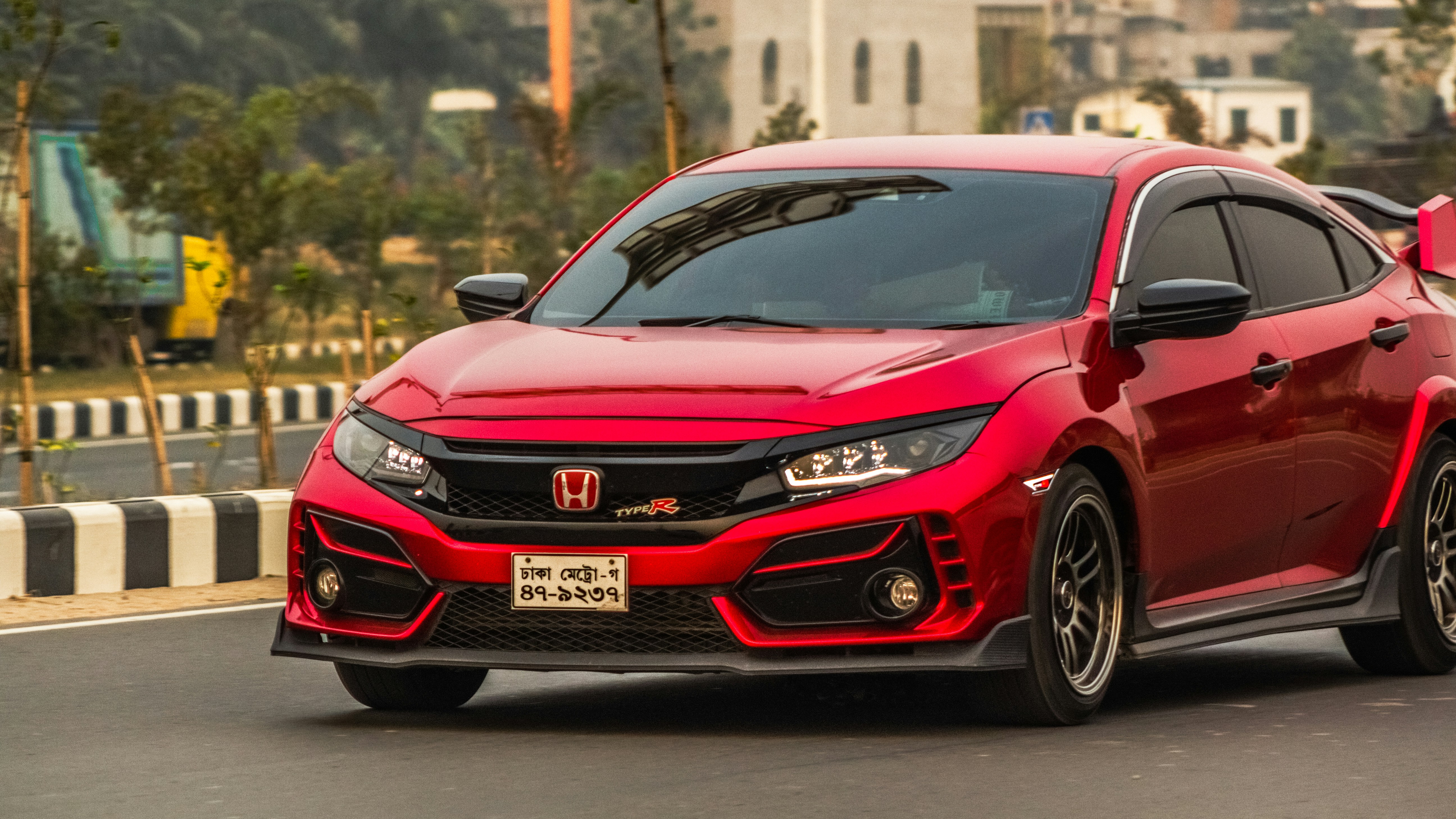 A red honda civic type car driving down a road photo – Free Red Image ...