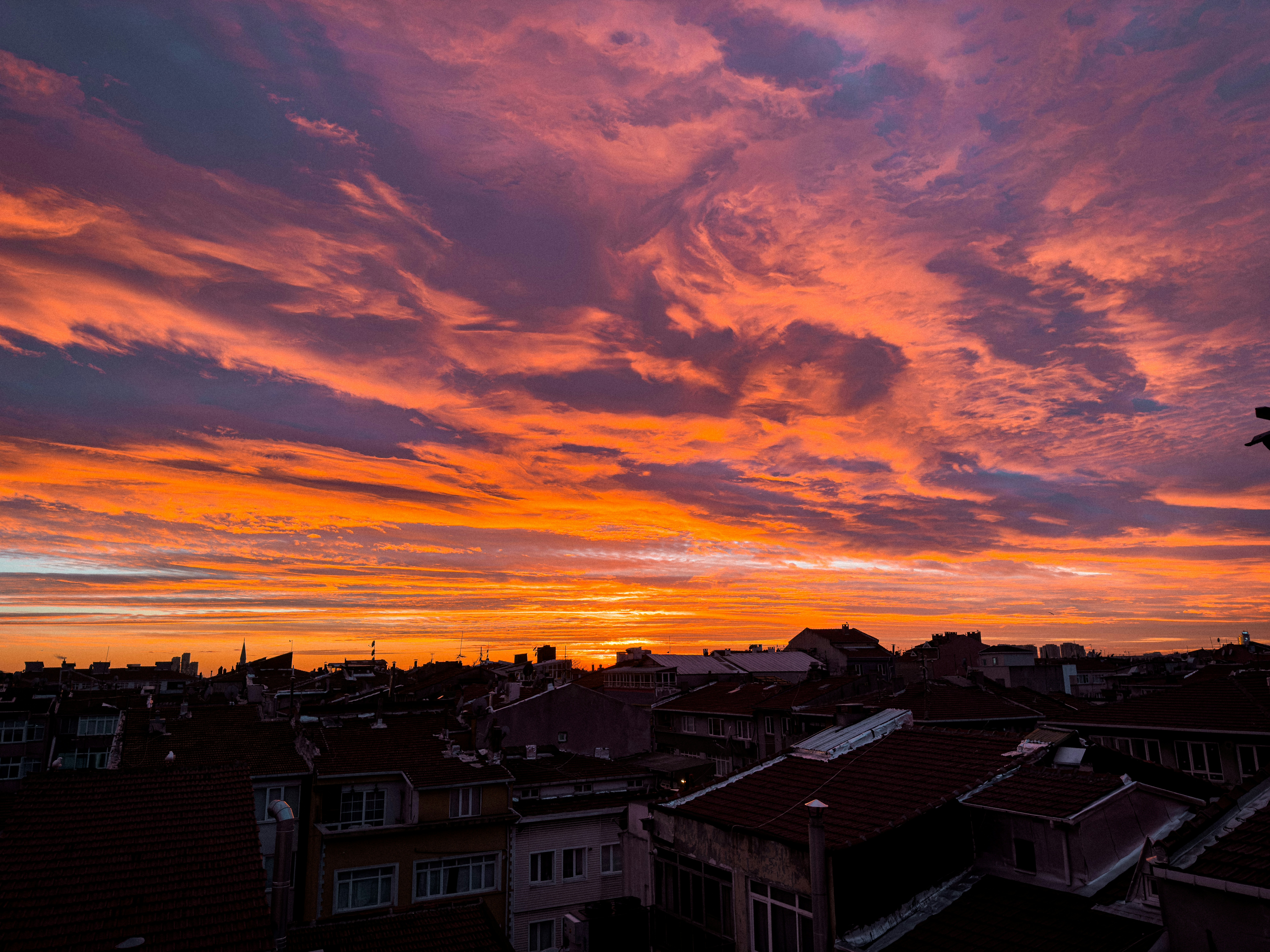 Horizon in Flame: Rooftops Beneath a Fiery Sunset
