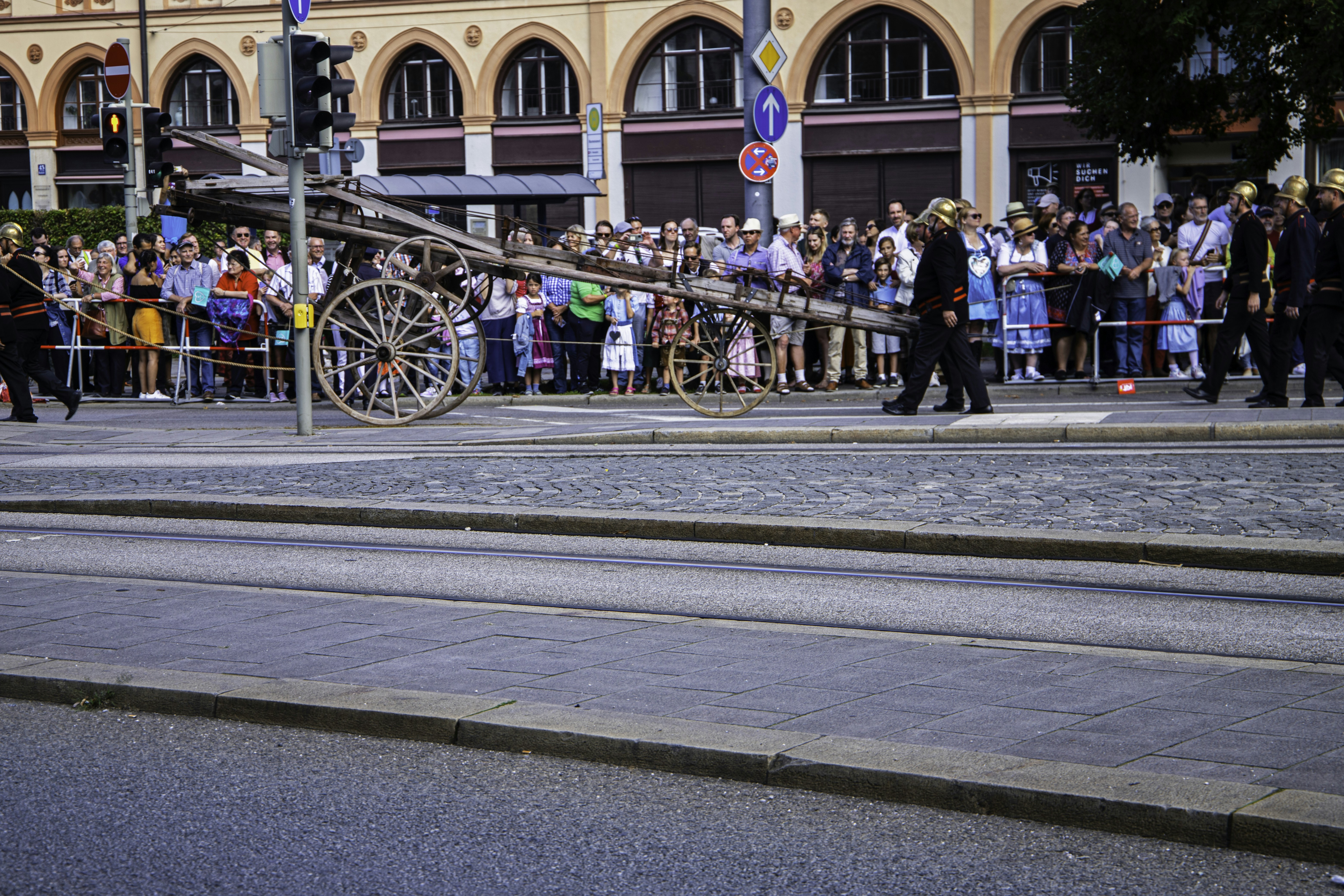A crowd of people watching a man on a horse drawn carriage photo – Free ...