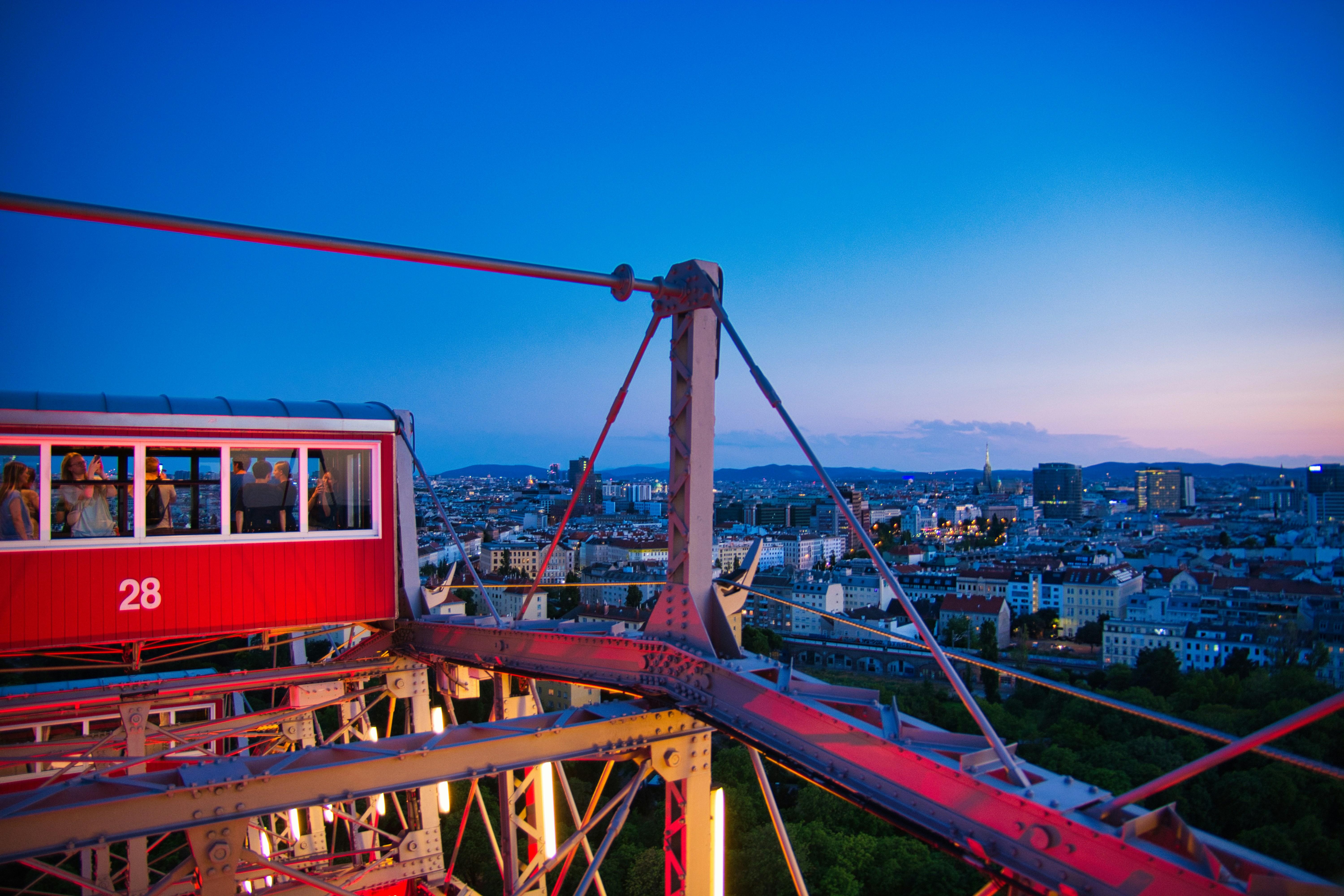 A red and white train traveling over a bridge photo – Free Prater Image ...