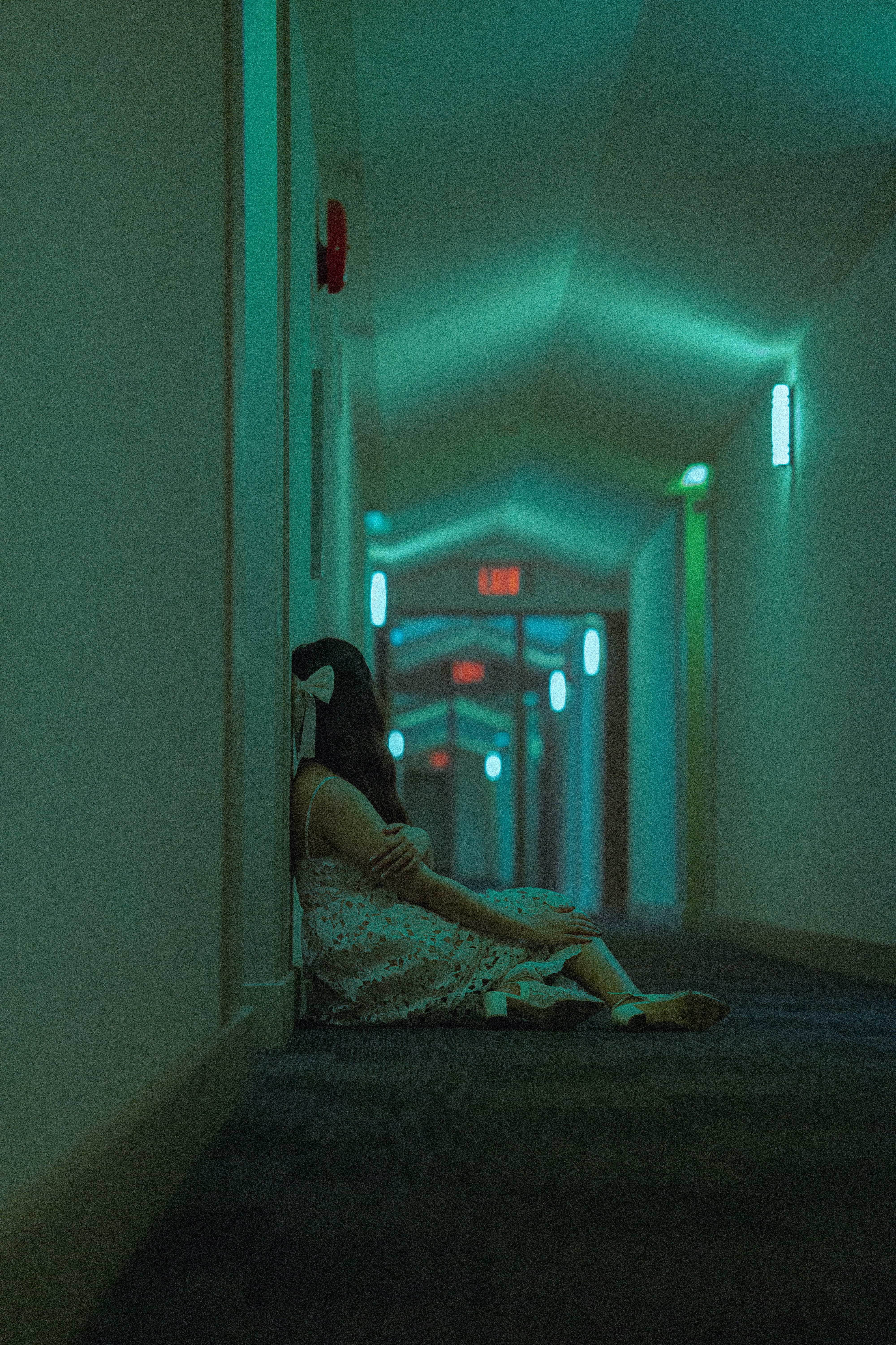 Teal Hallway Solitude: A Quiet Portrait in Neon Light