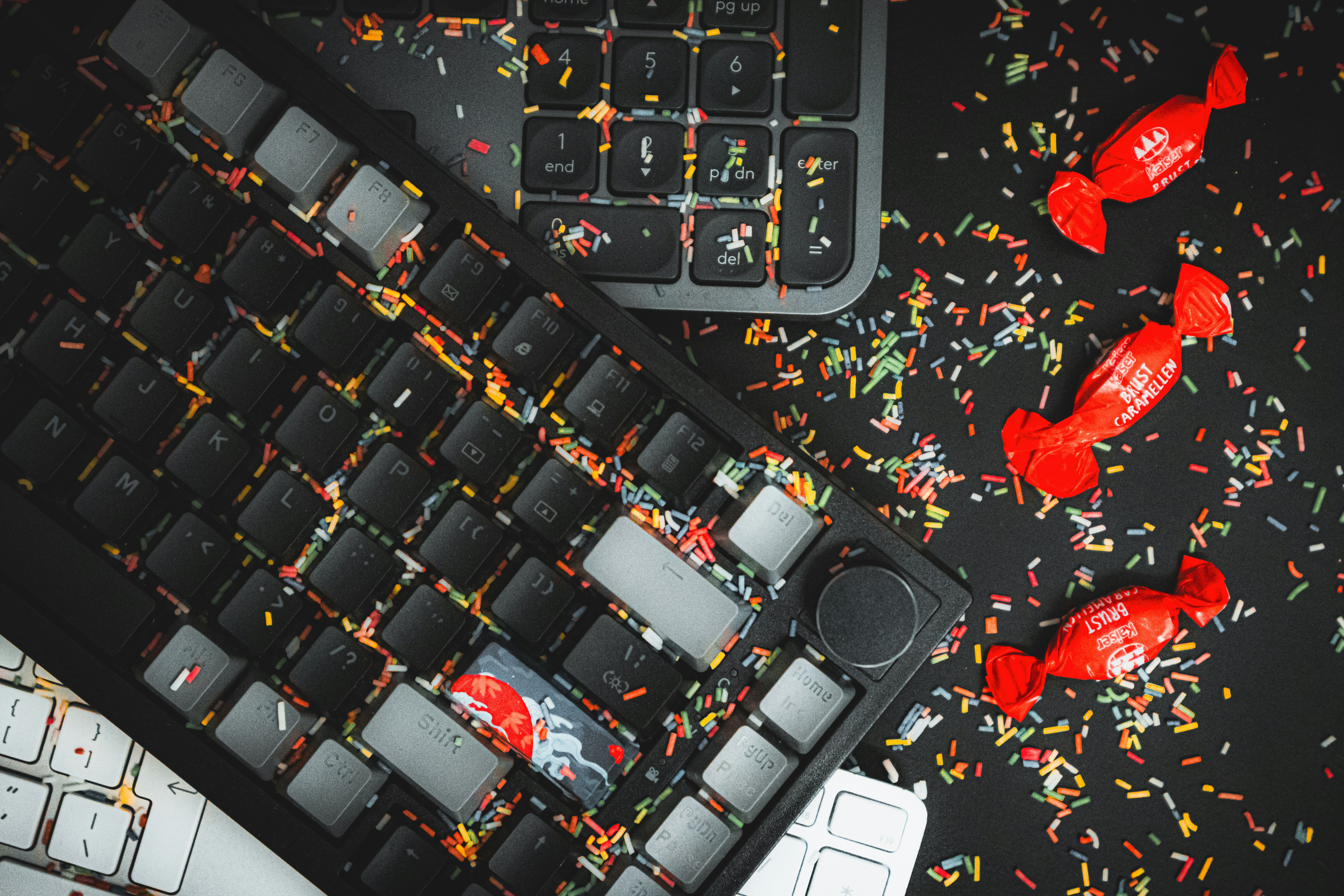A keyboard and a keyboard with candy on it photo – Free Red Image on ...