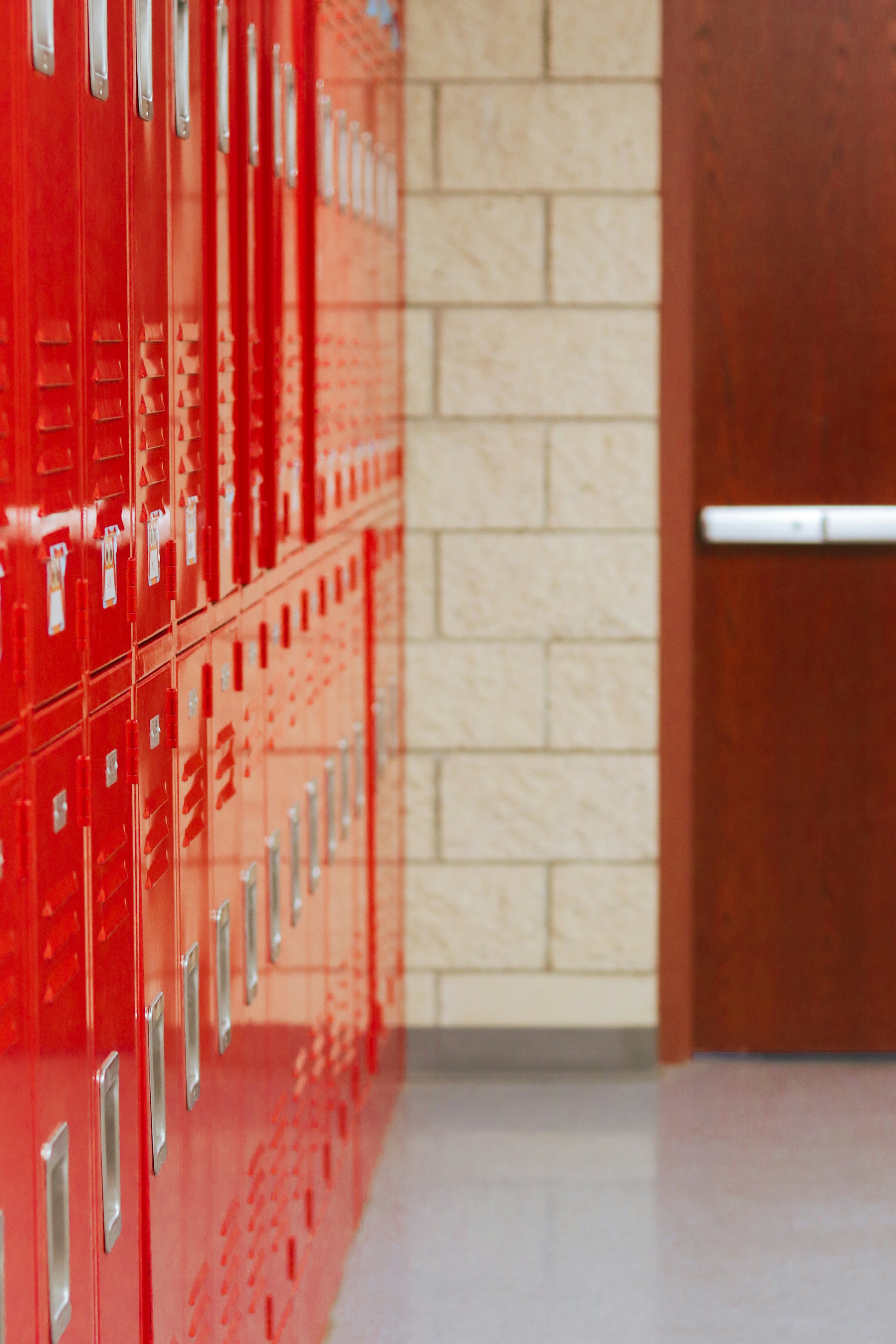 A row of red lockers in front of a brick wall photo – Free Red Image on ...