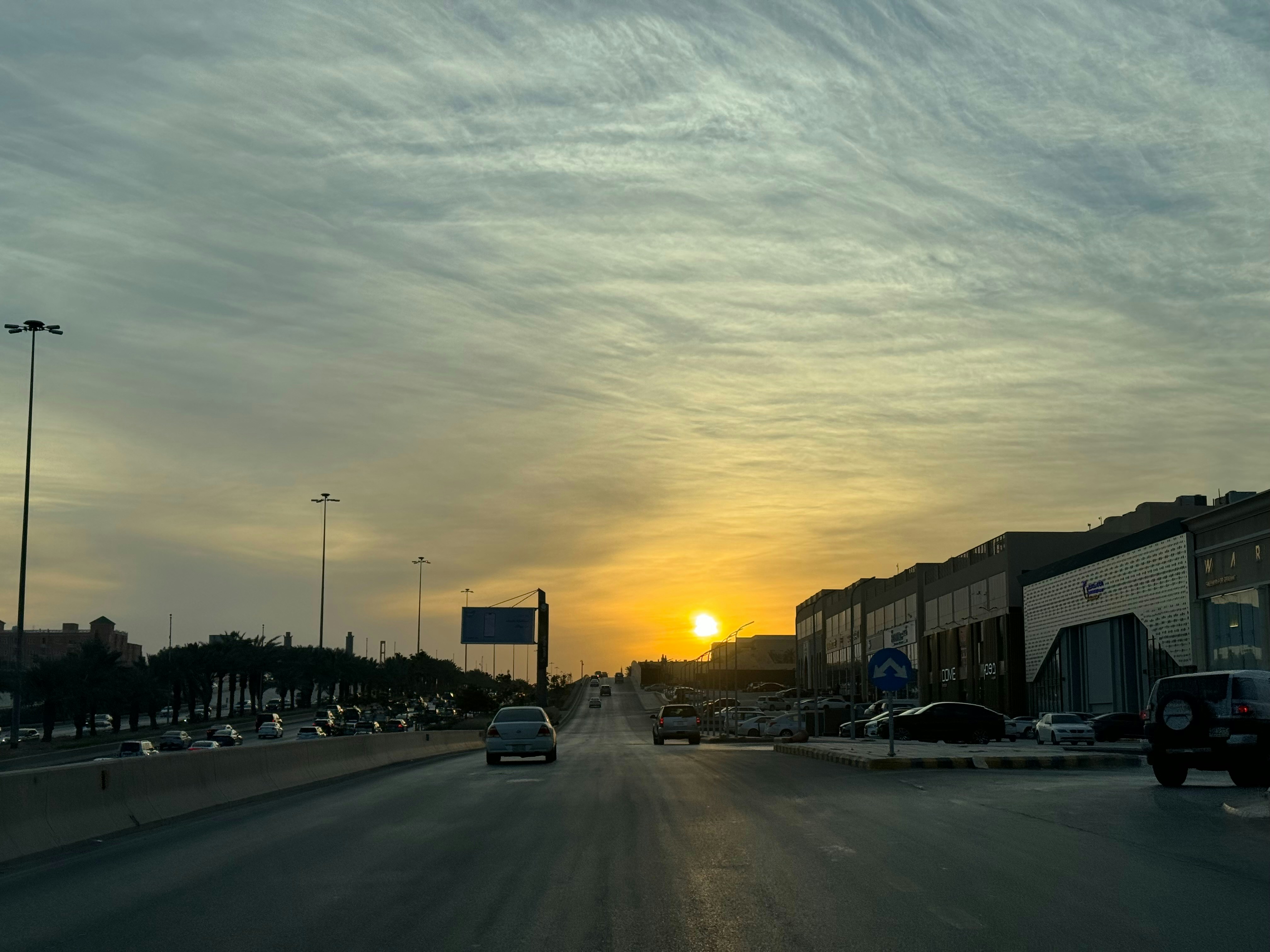 Golden Hour Gridlock: Sunset Illuminates a Busy Boulevard