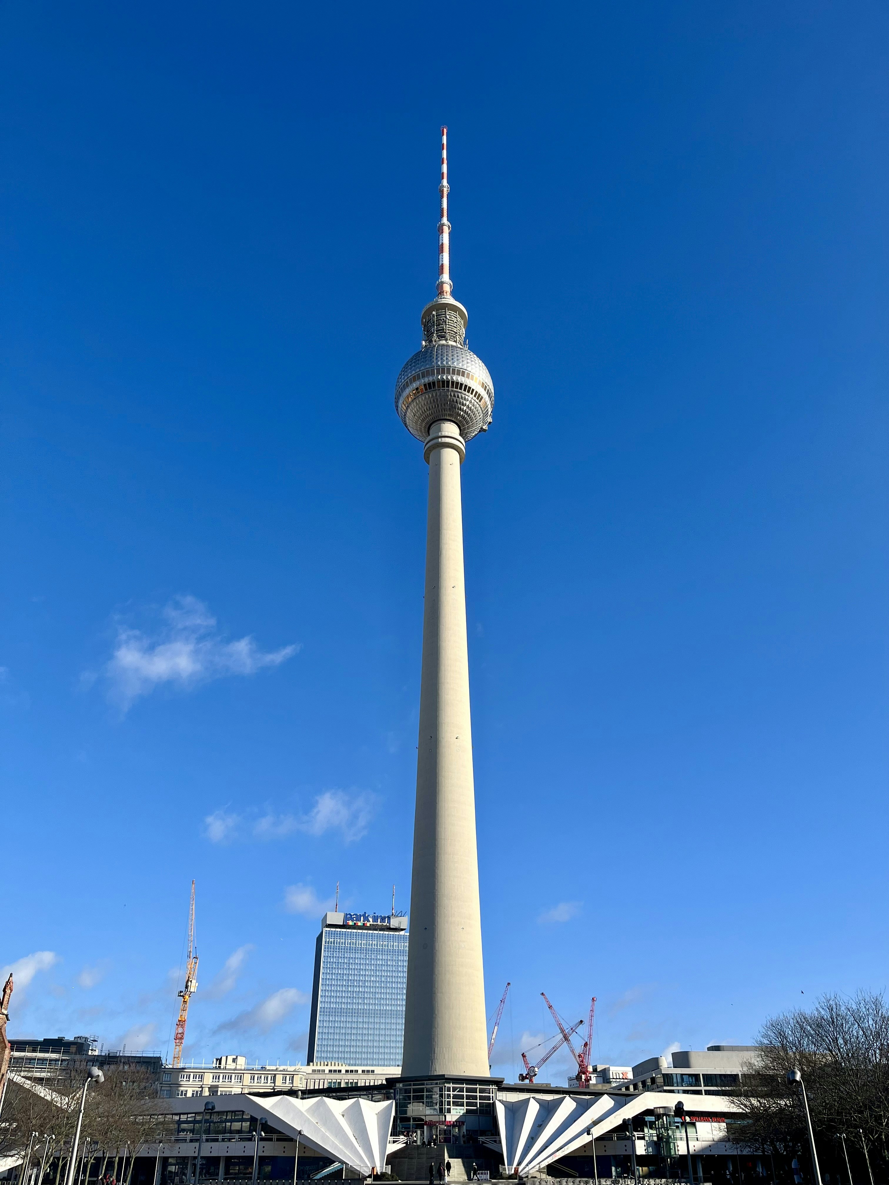 A tall tower with a sky scraper in the background photo – Free Blue ...