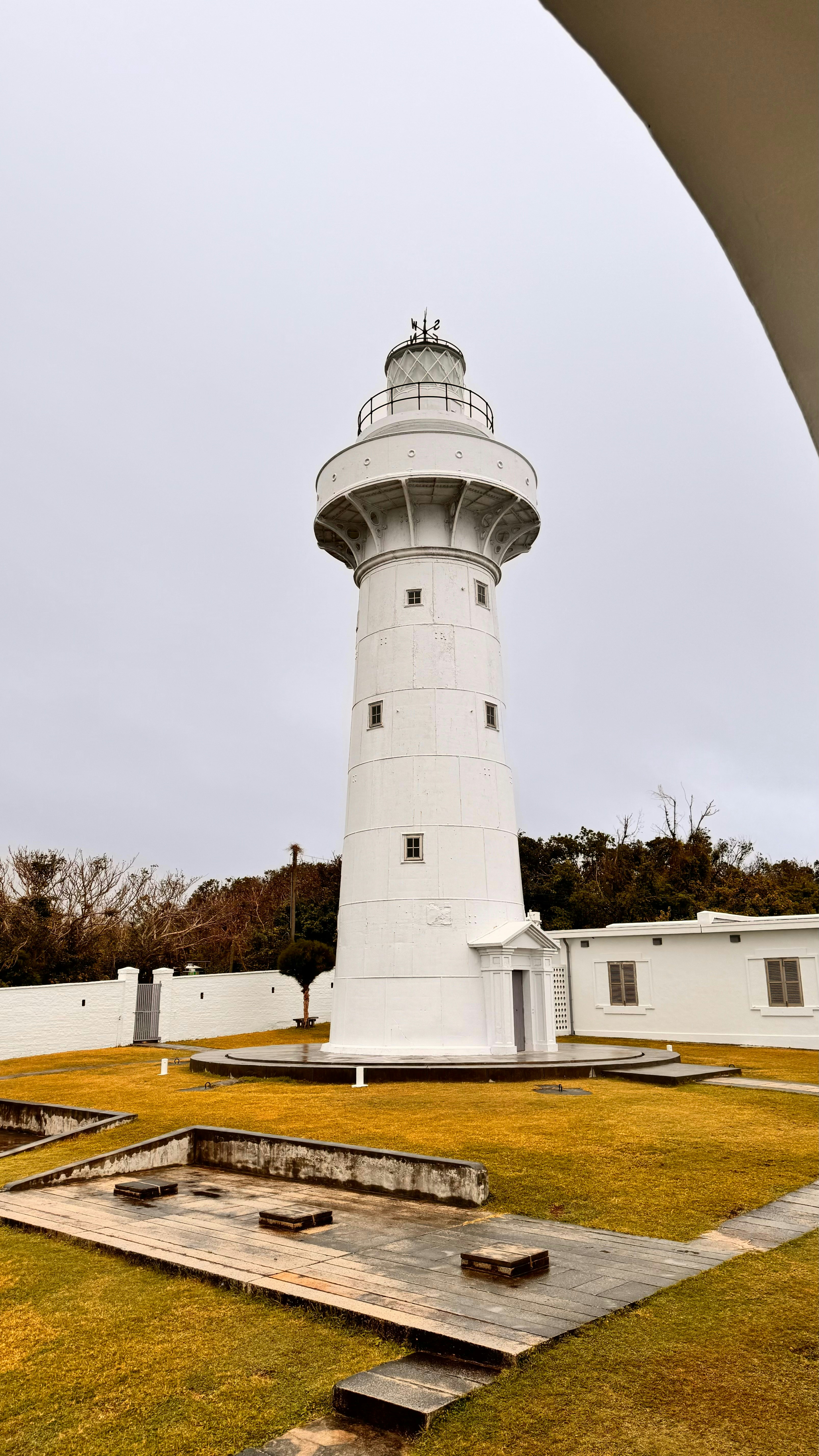 Ivory Beacon Over a Quiet Coastal Courtyard