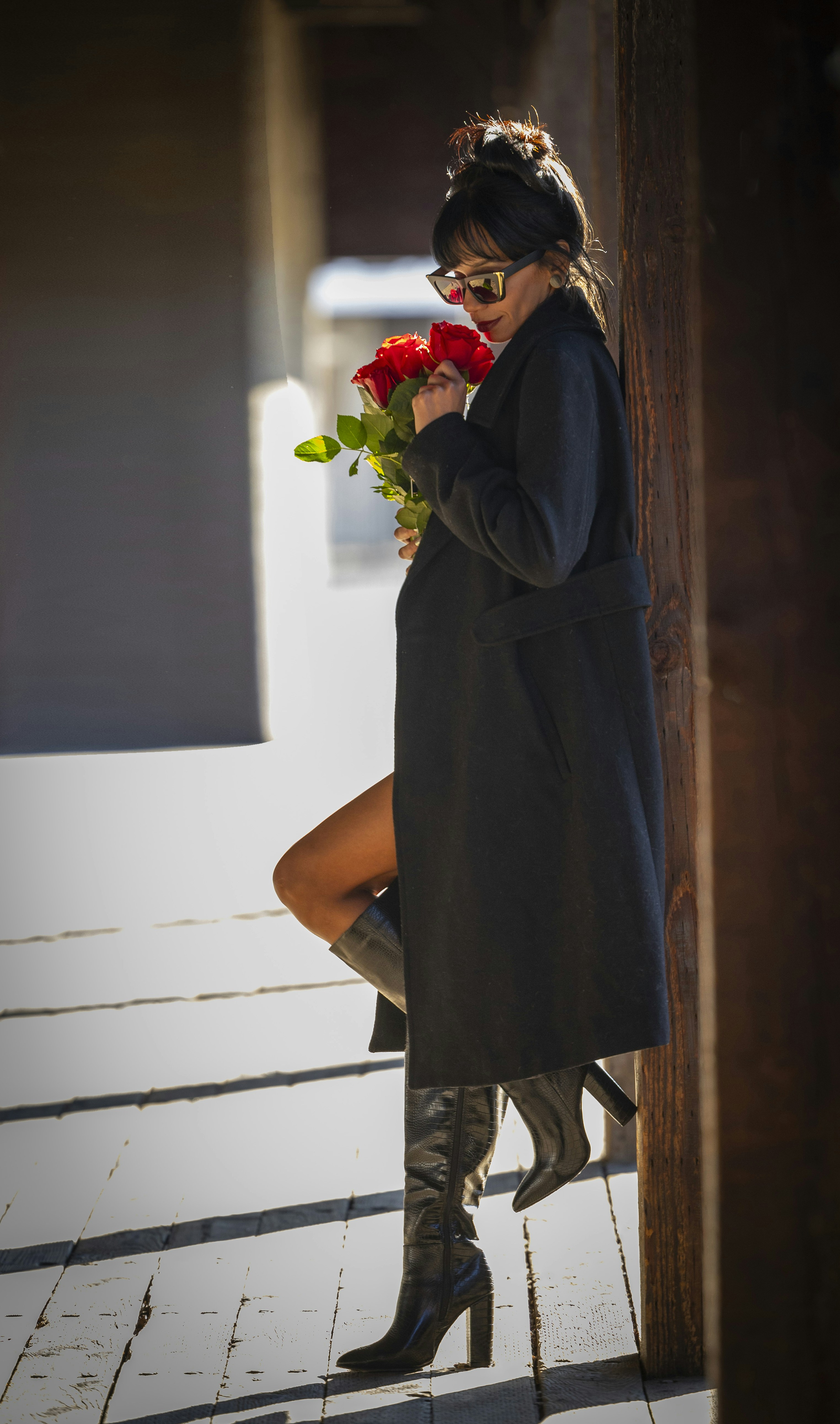 Red Roses at the Pillar: A Quiet Portrait in Velvet Light
