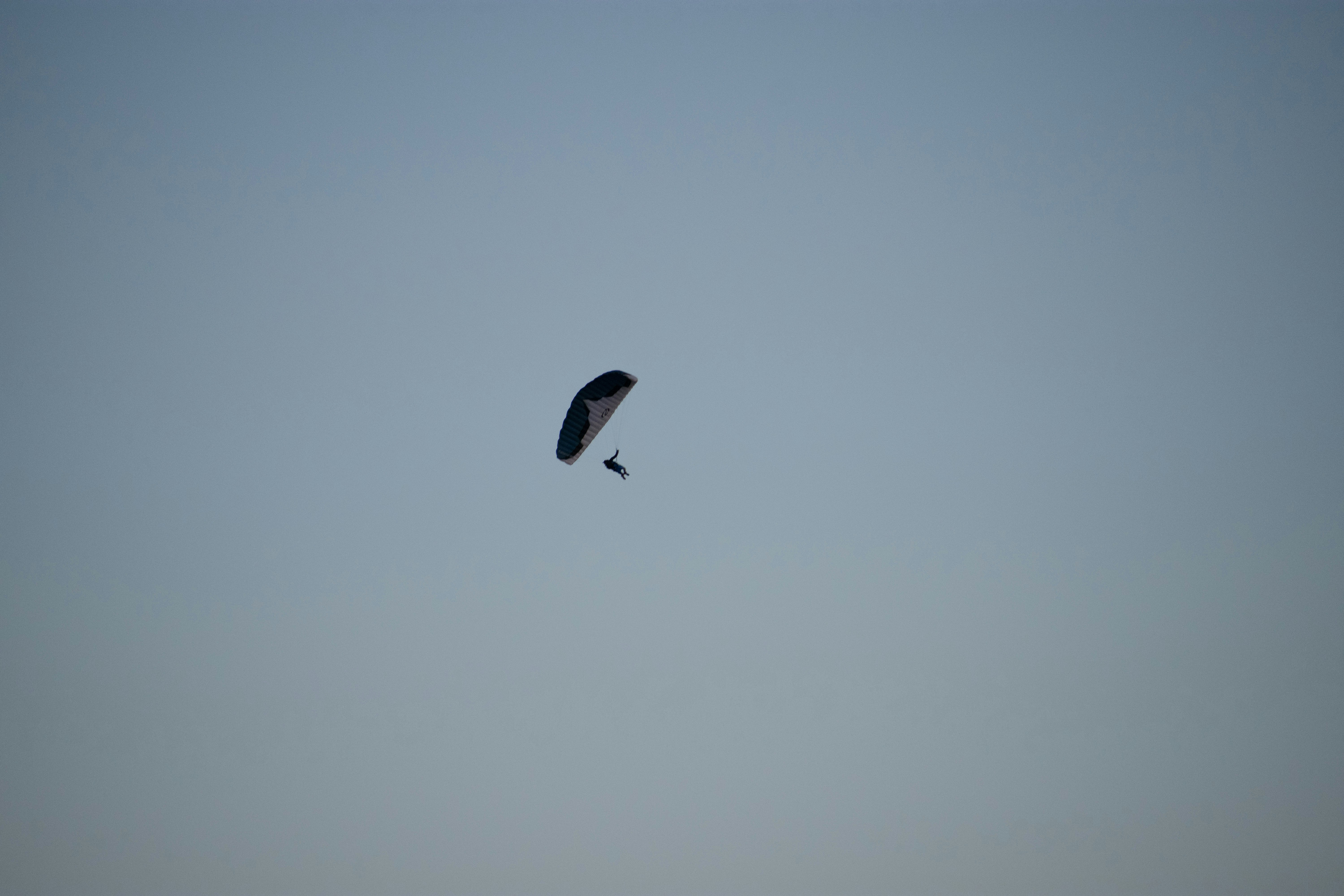 Single Paraglider Carves a Quiet Gradient Across the Sky