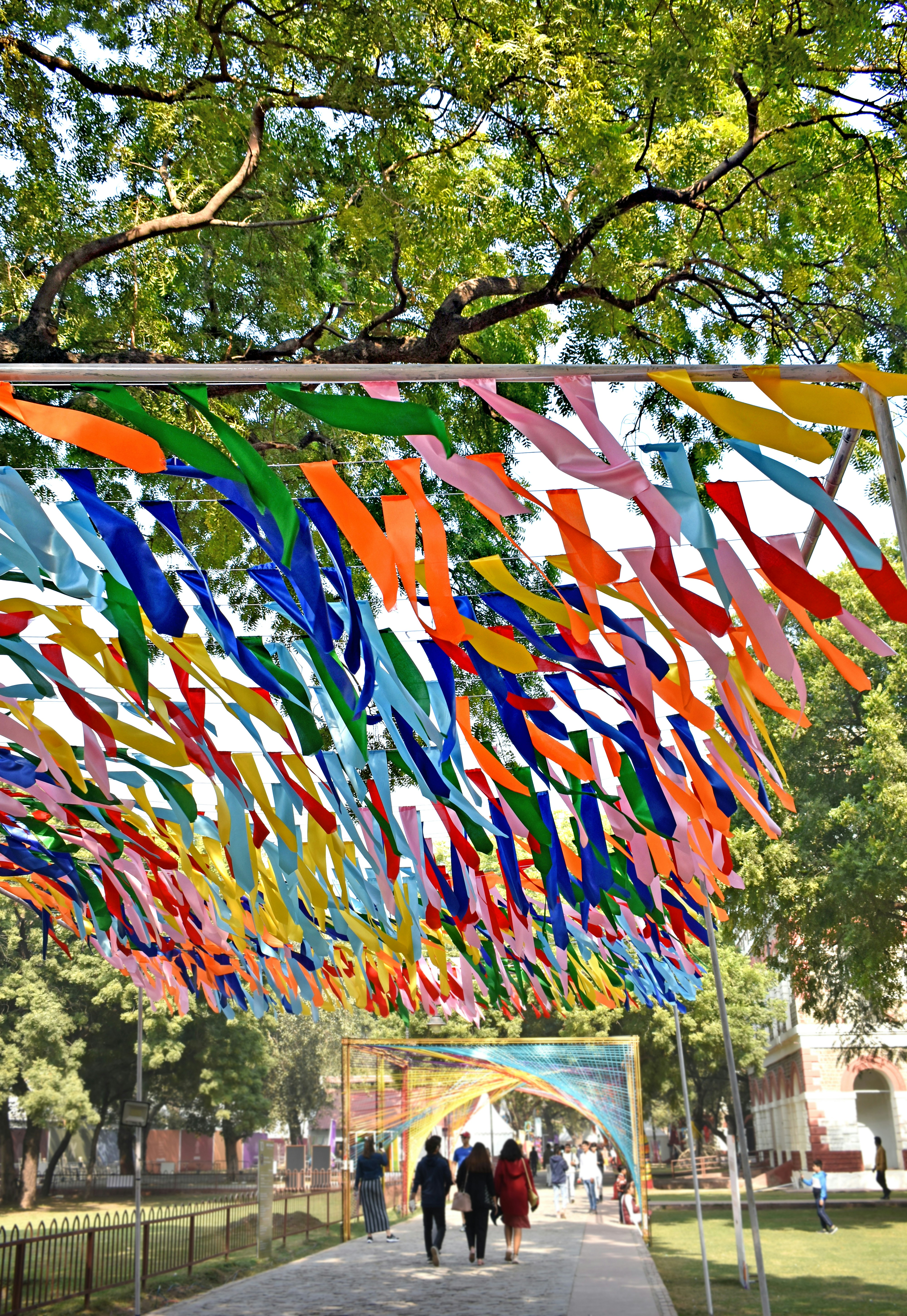 A group of people walking under a canopy of colorful streamers photo ...