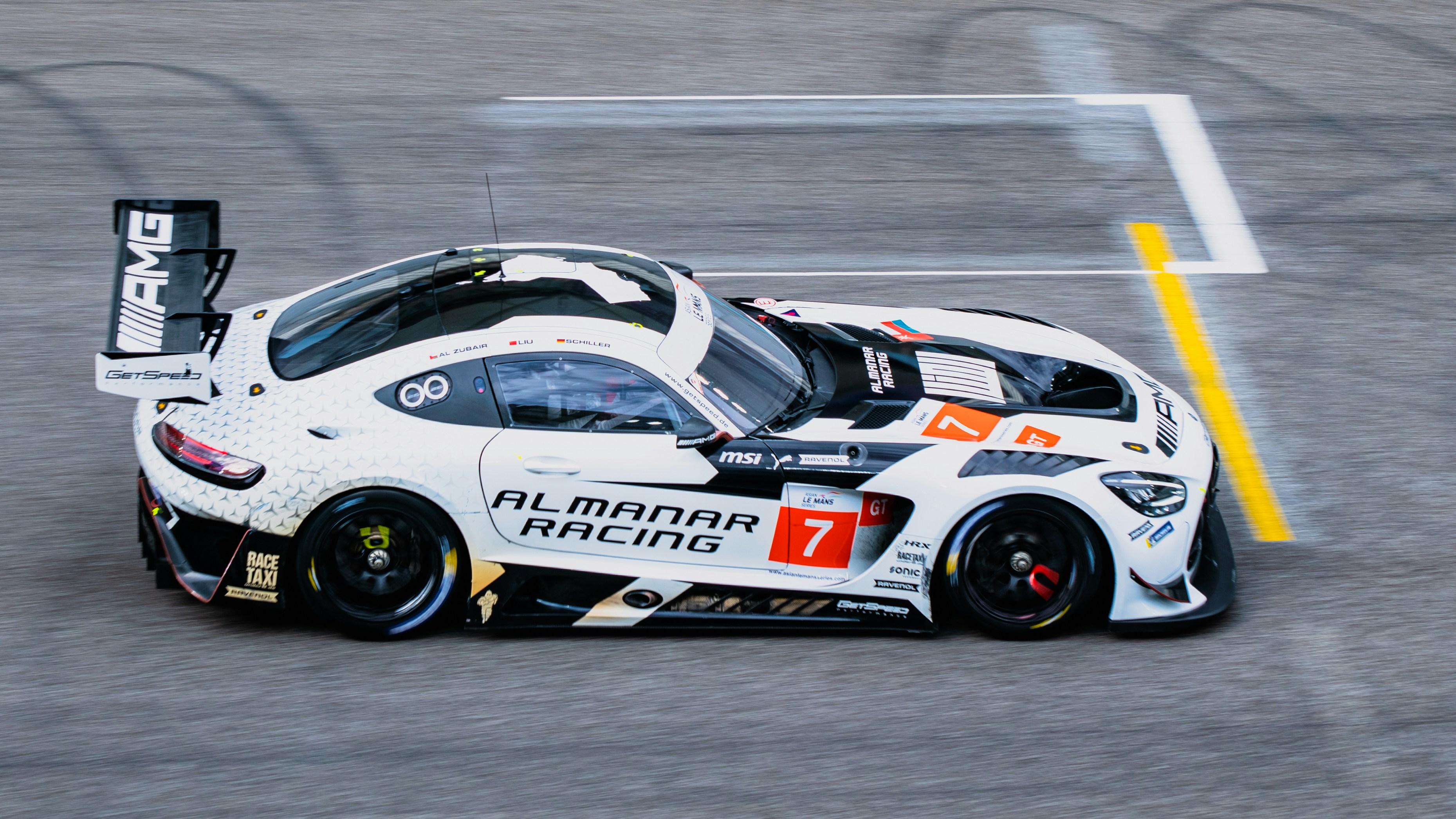 A white race car driving down a race track photo – Free Automobile ...