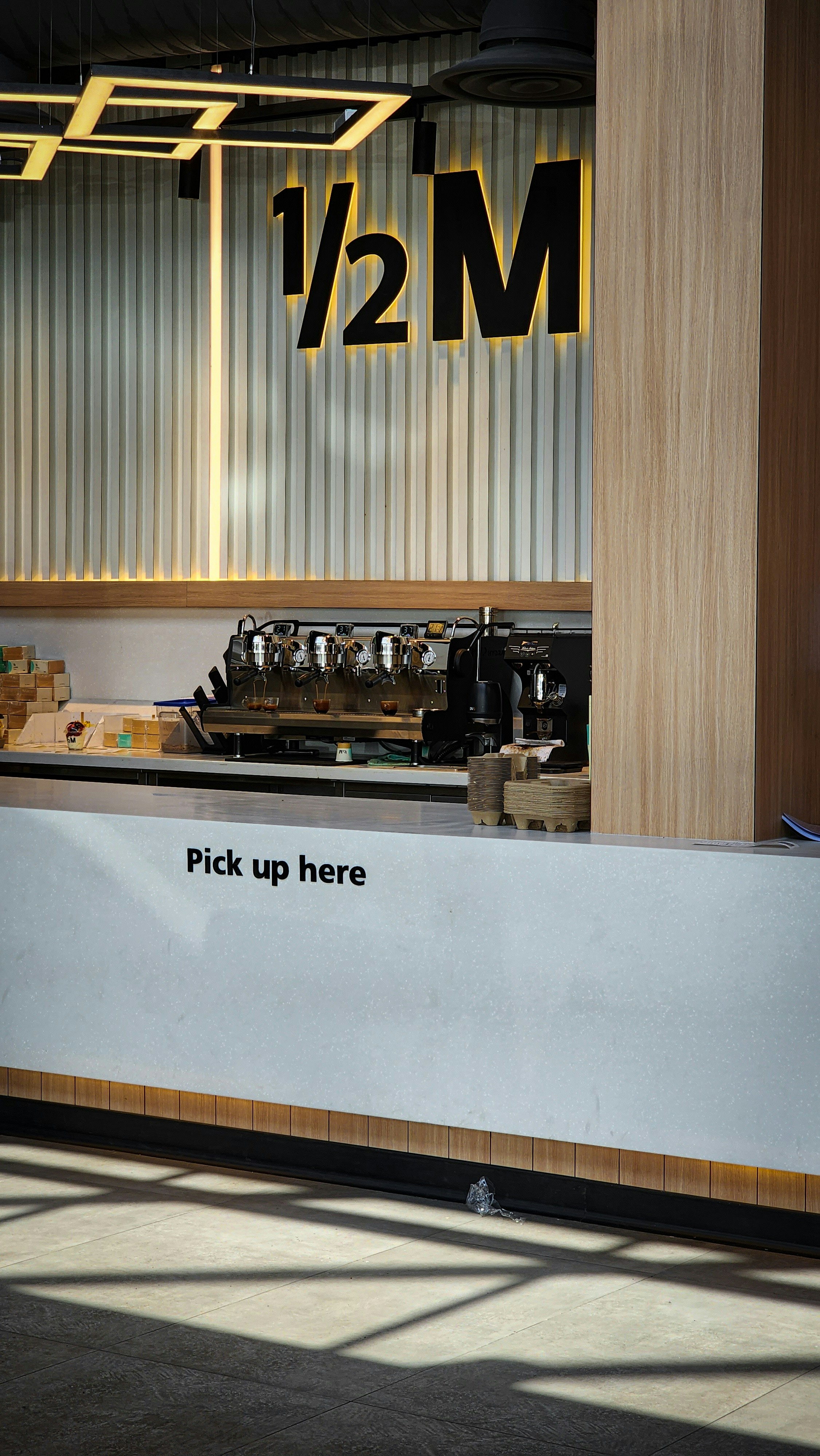 A white counter with a sign that says pick up here photo – Free ...