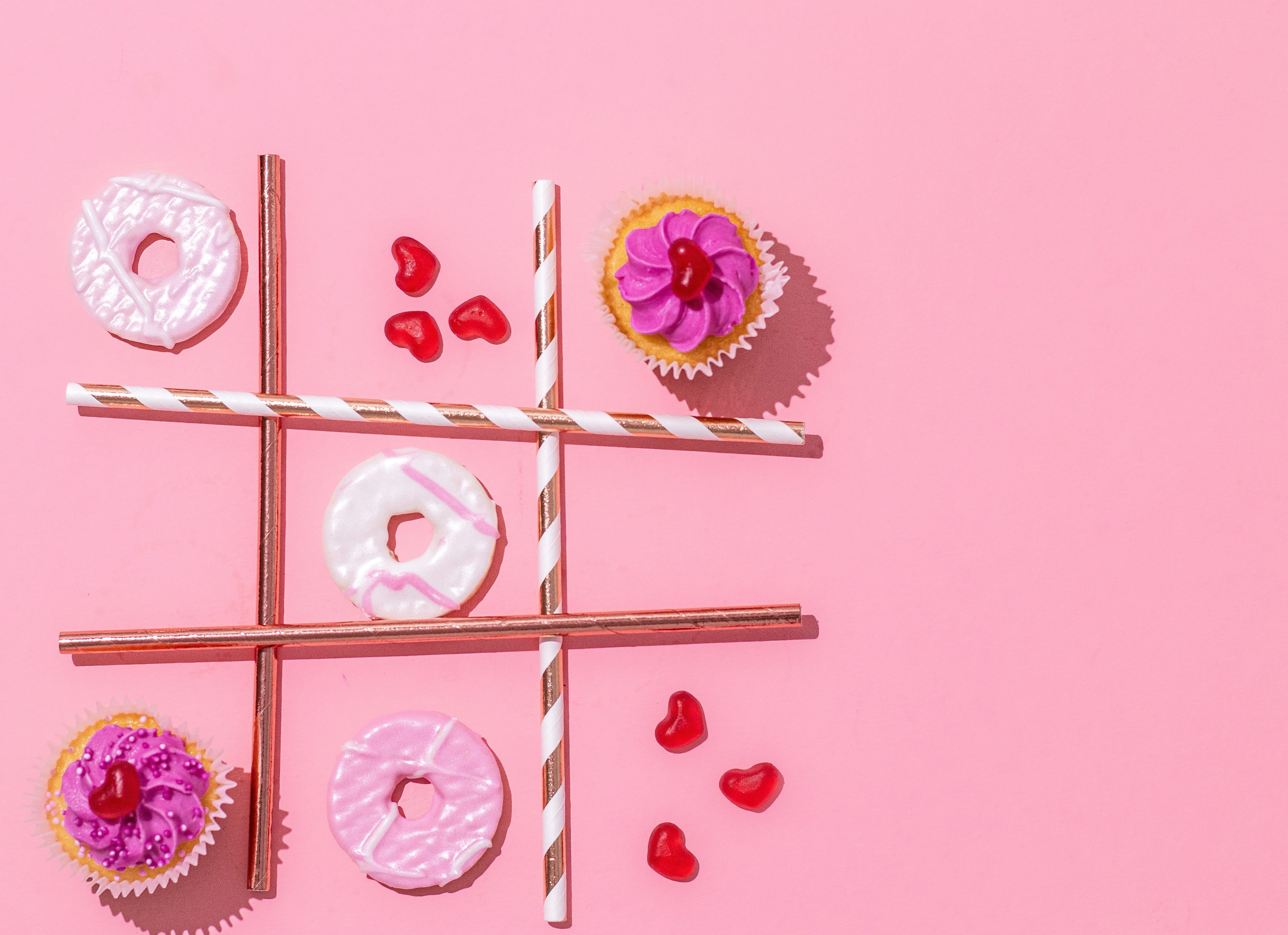 Pink Grid of Delights: A Tic-Tac-Toe Still-Life of Donuts and Cupcake on a Metallic Frame