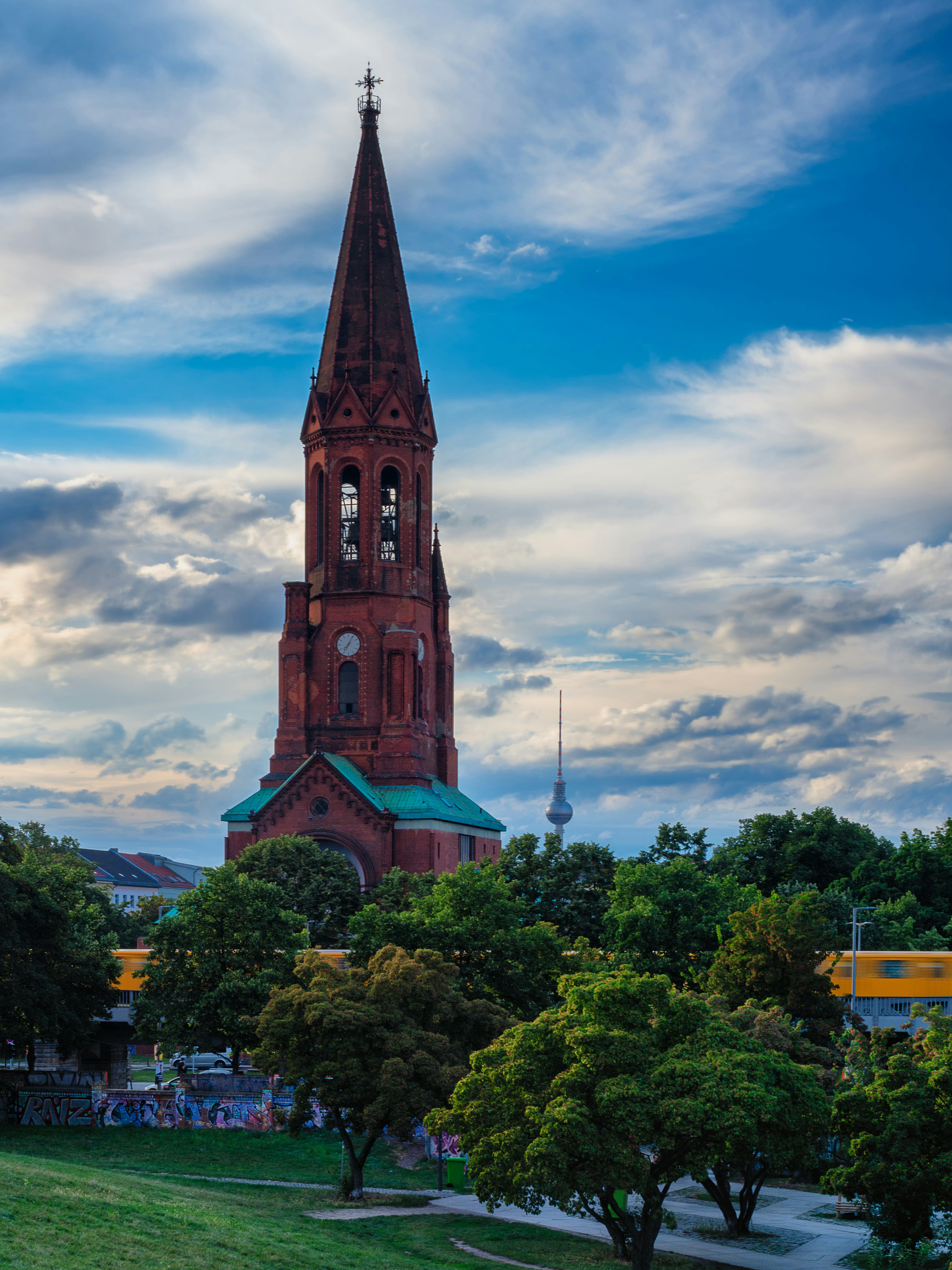Stained tower Pierces a Sky of Clouds over Riverside Greens