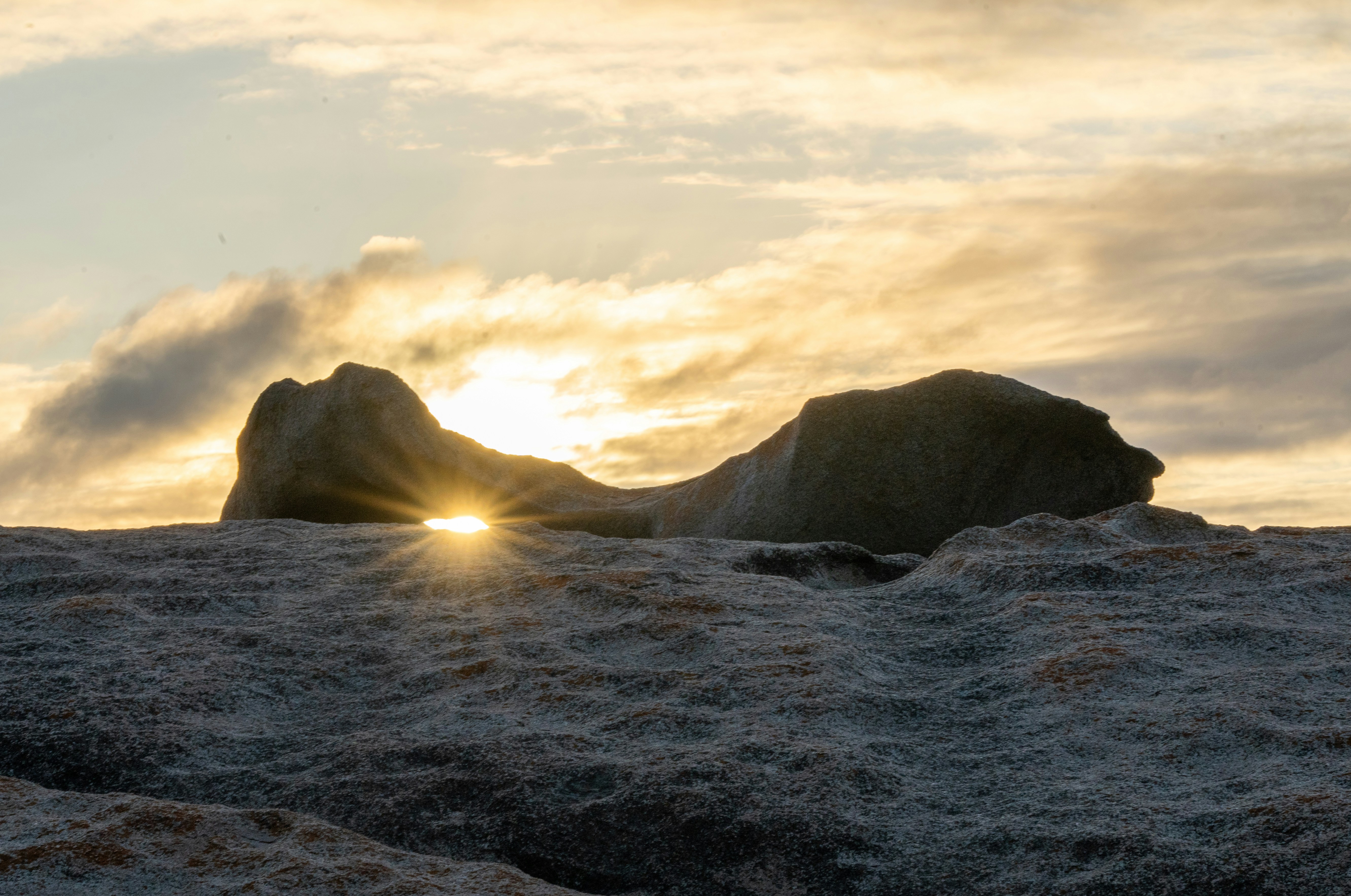 Sunrise Breach Over Coastal Rocks