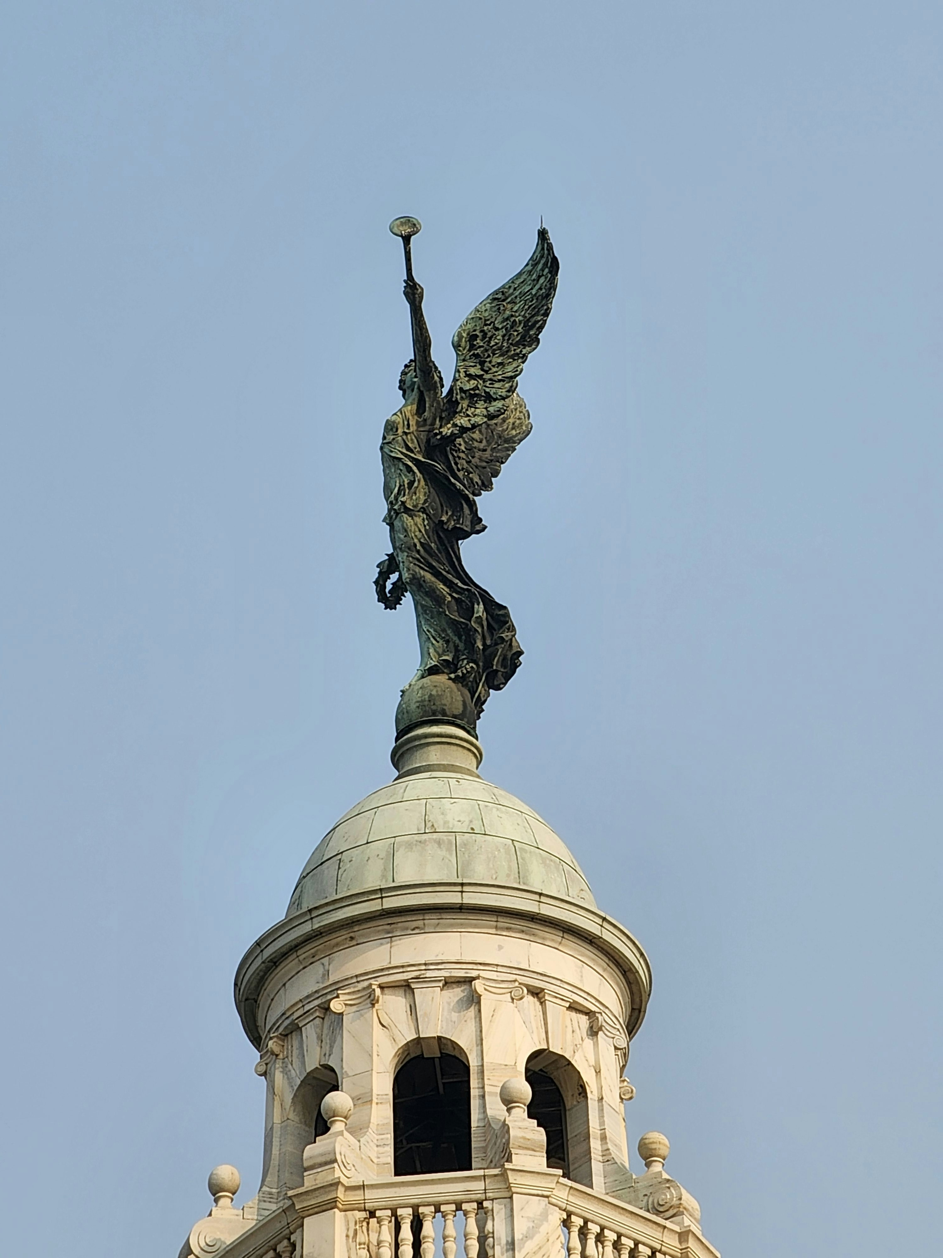 A statue of an angel on top of a building photo – Free Art Image on ...
