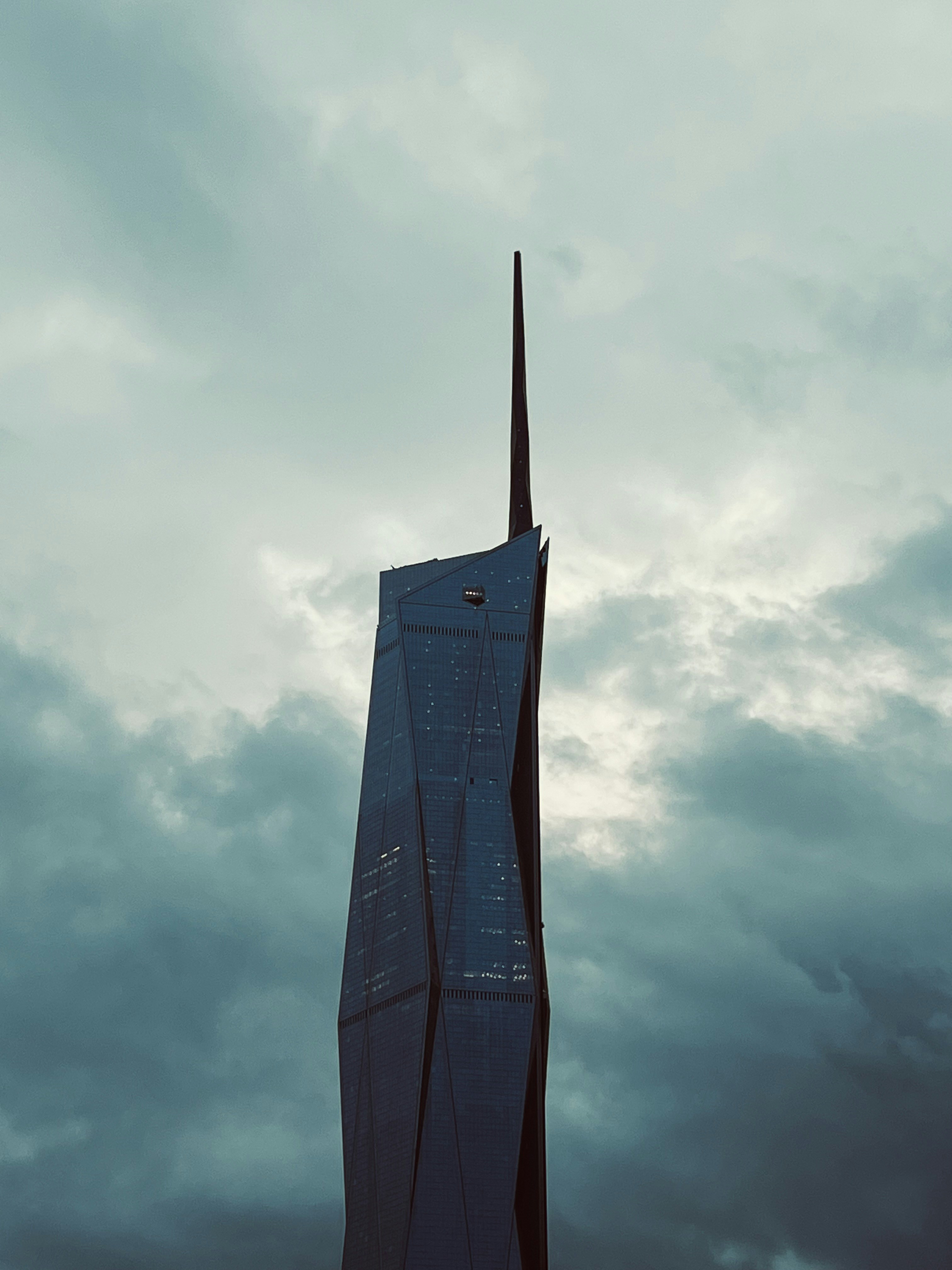 Skyward Needle: Steel Spire Piercing the Stormy Sky