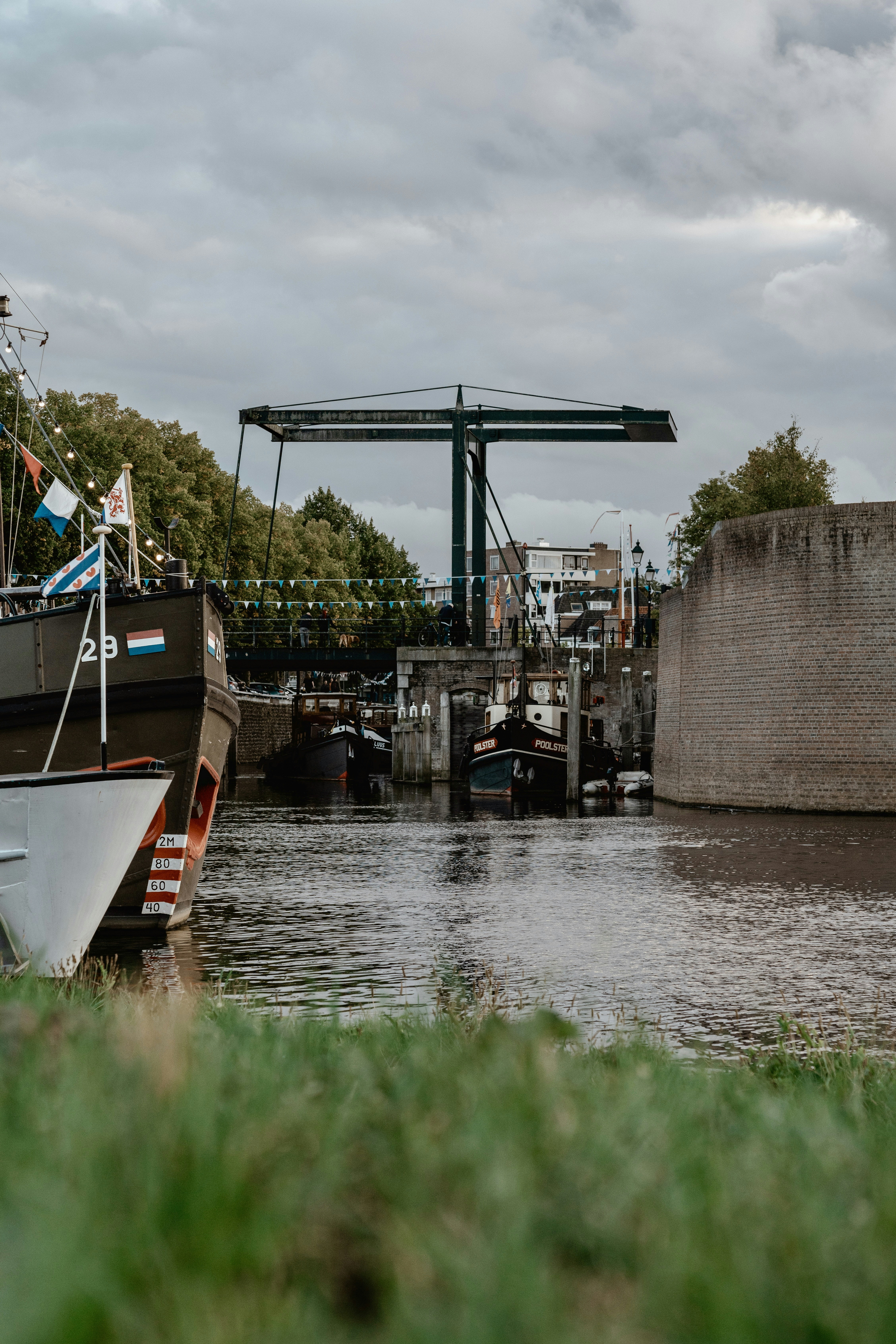 A boat sitting in the water next to a bridge photo – Free Netherlands ...