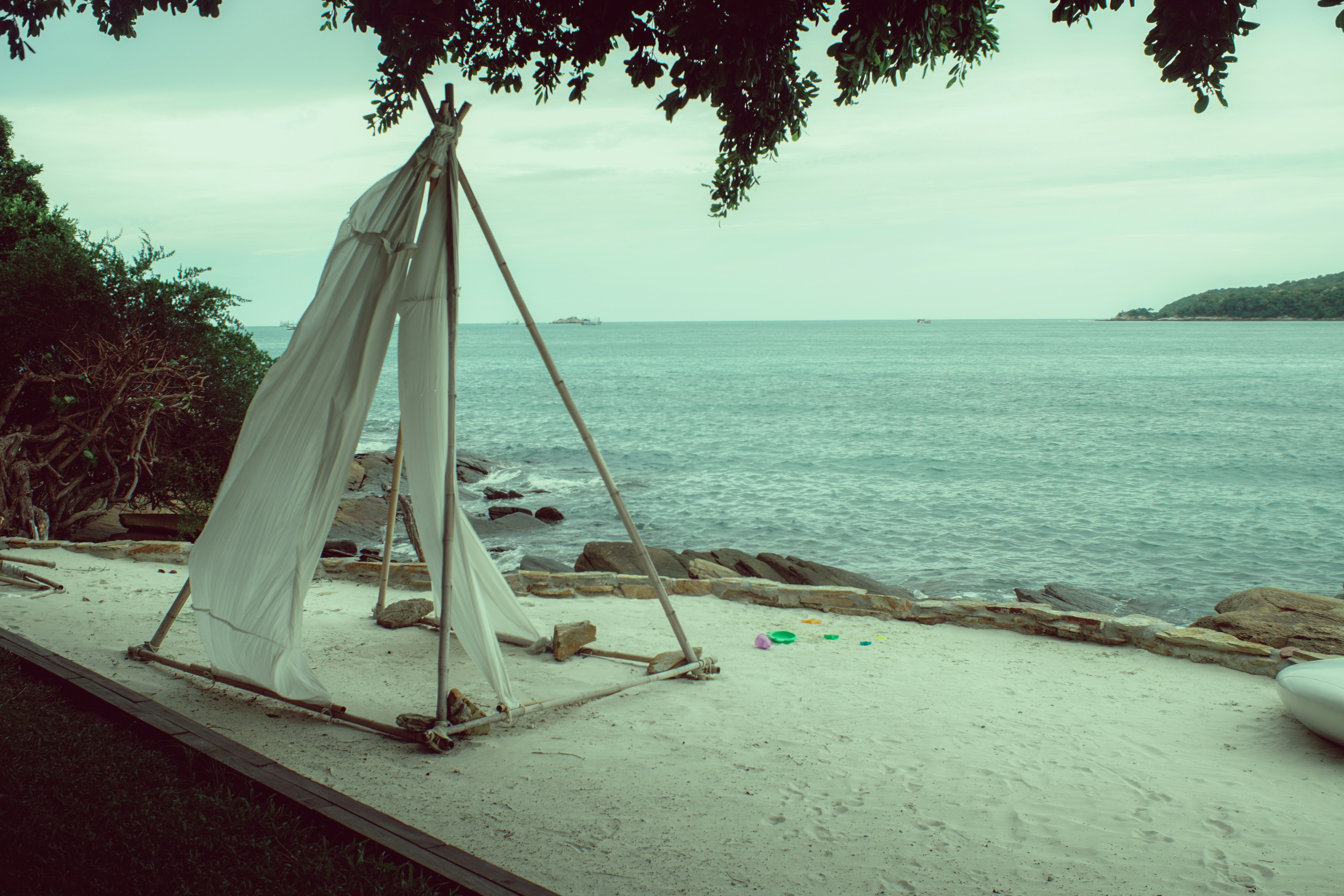 Tent-draped Shelter on a Quiet Seaside Shore
