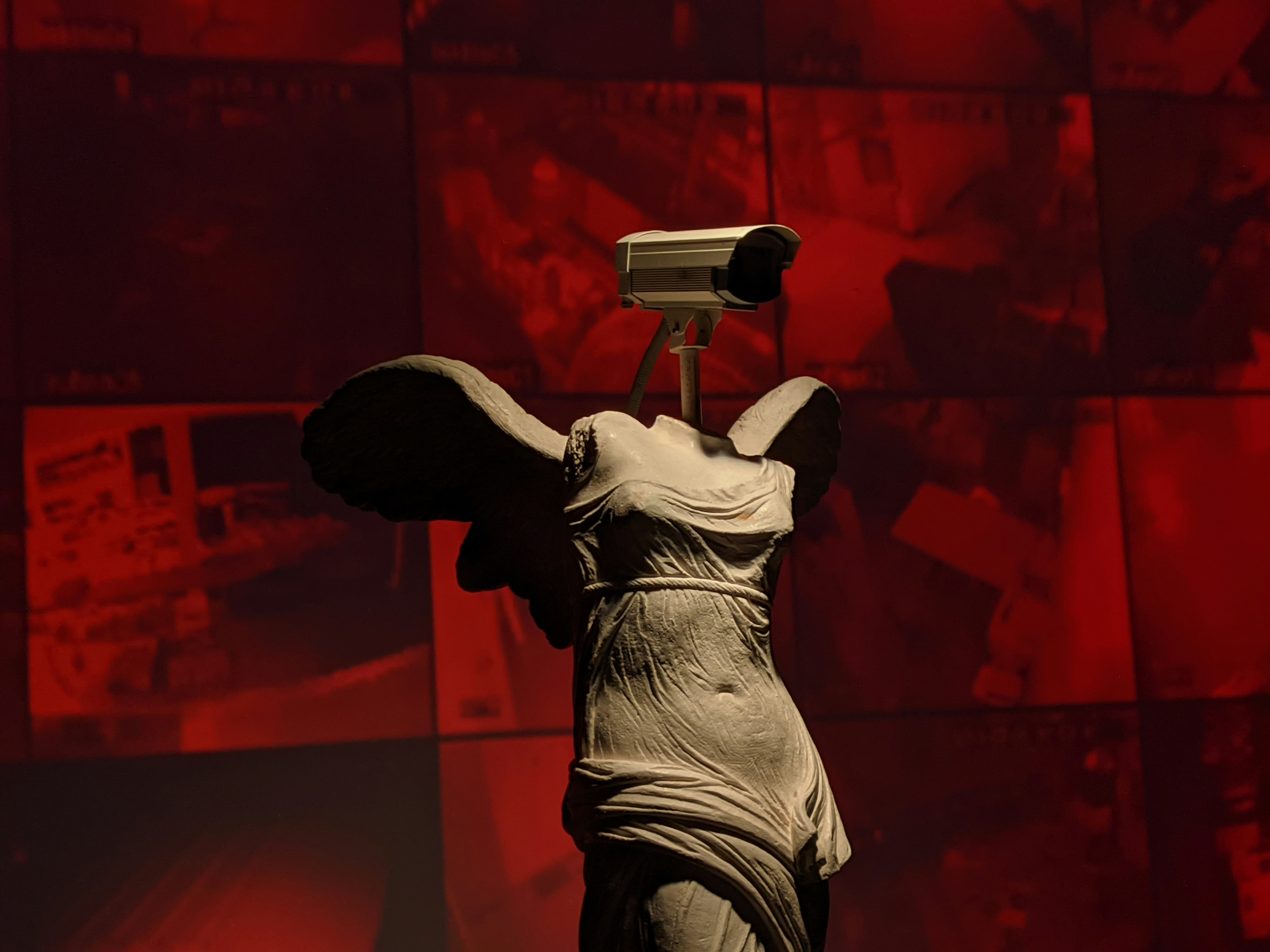 a statue of a woman with a camera on her head