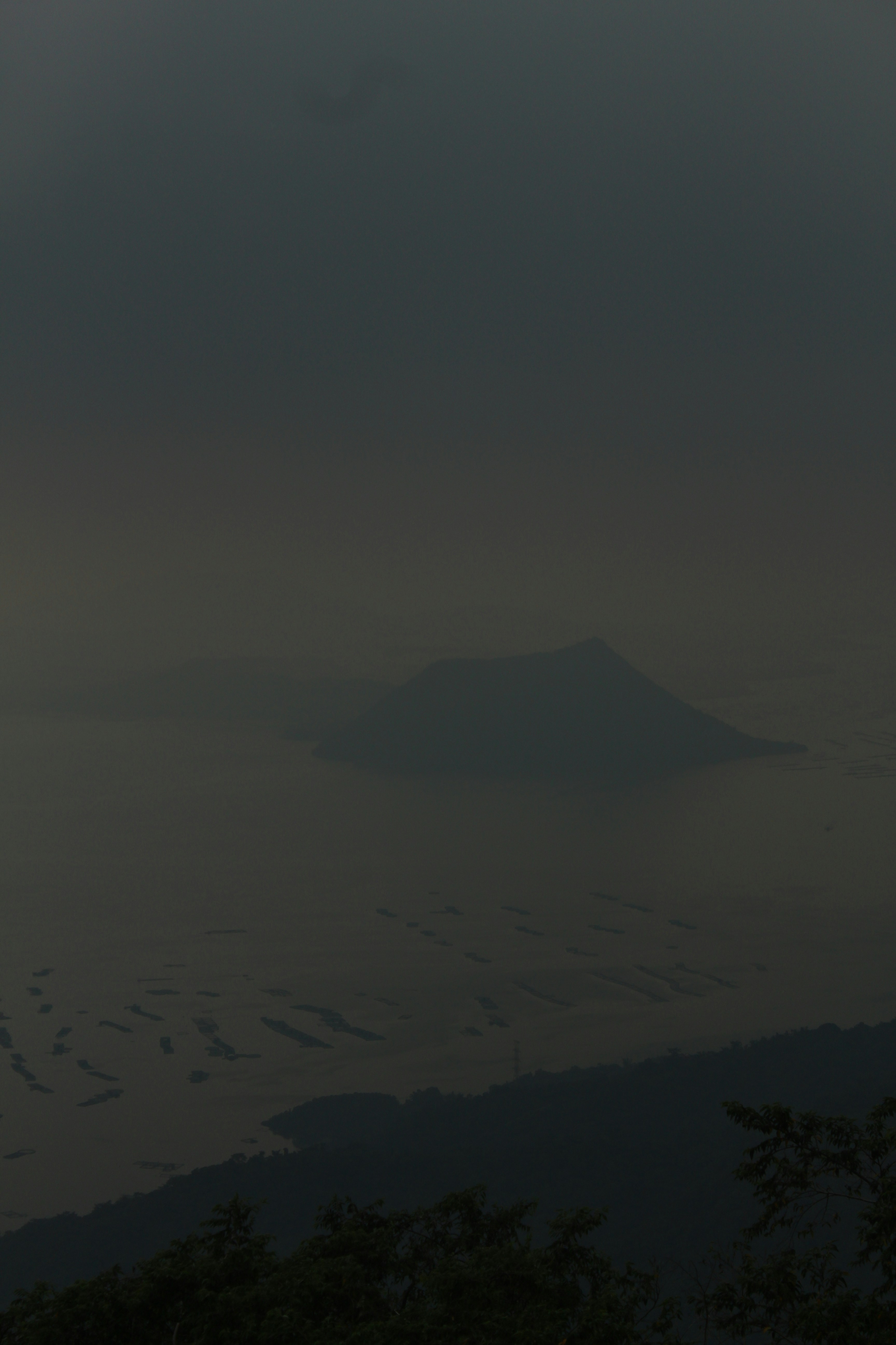 Dusk Sentinel: Silhouette Island Drifting Across a Misty Sea