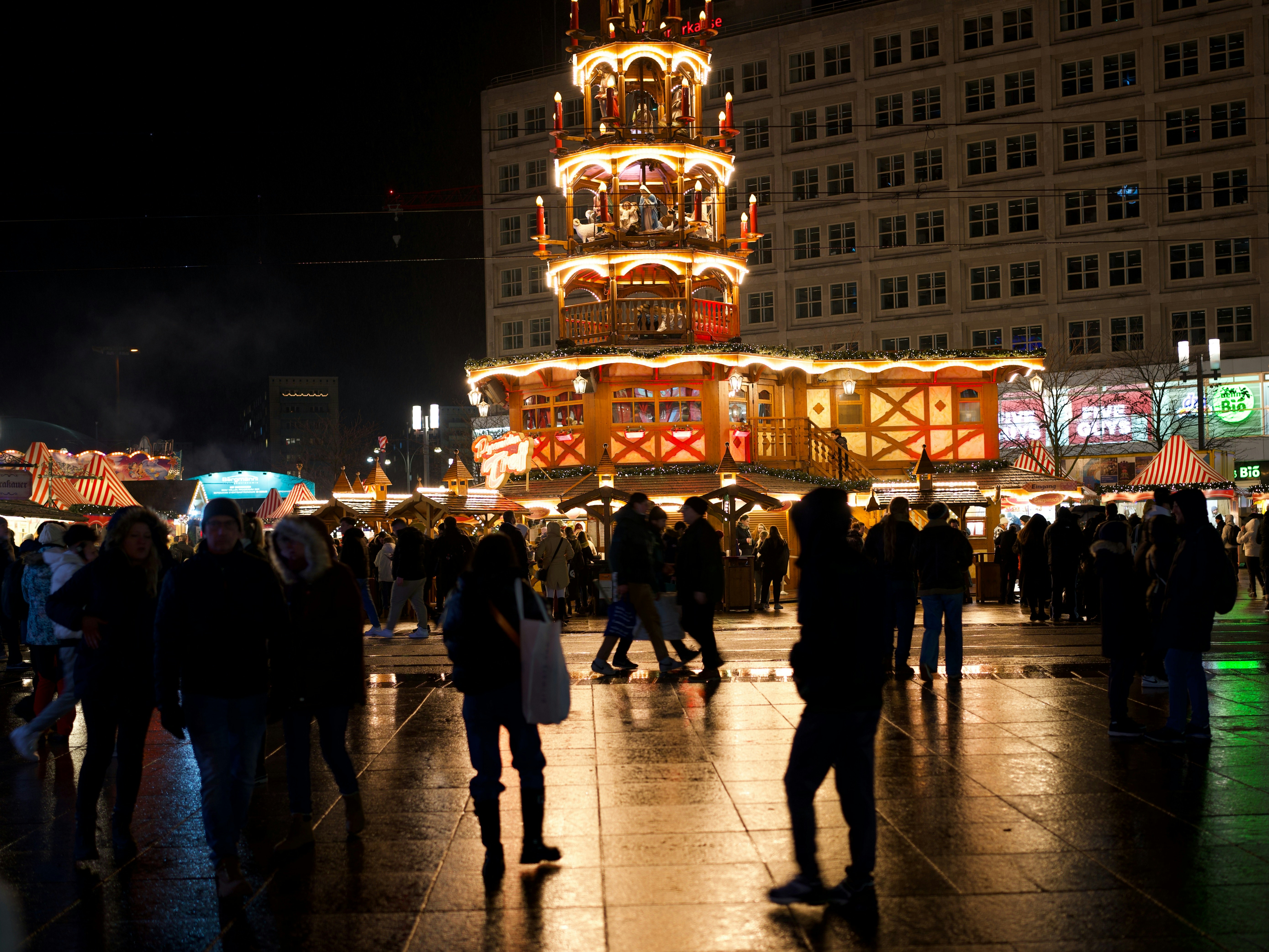Illuminated Pagoda at the Night Market: Rain-Slick Reflections and Crowded Stalls