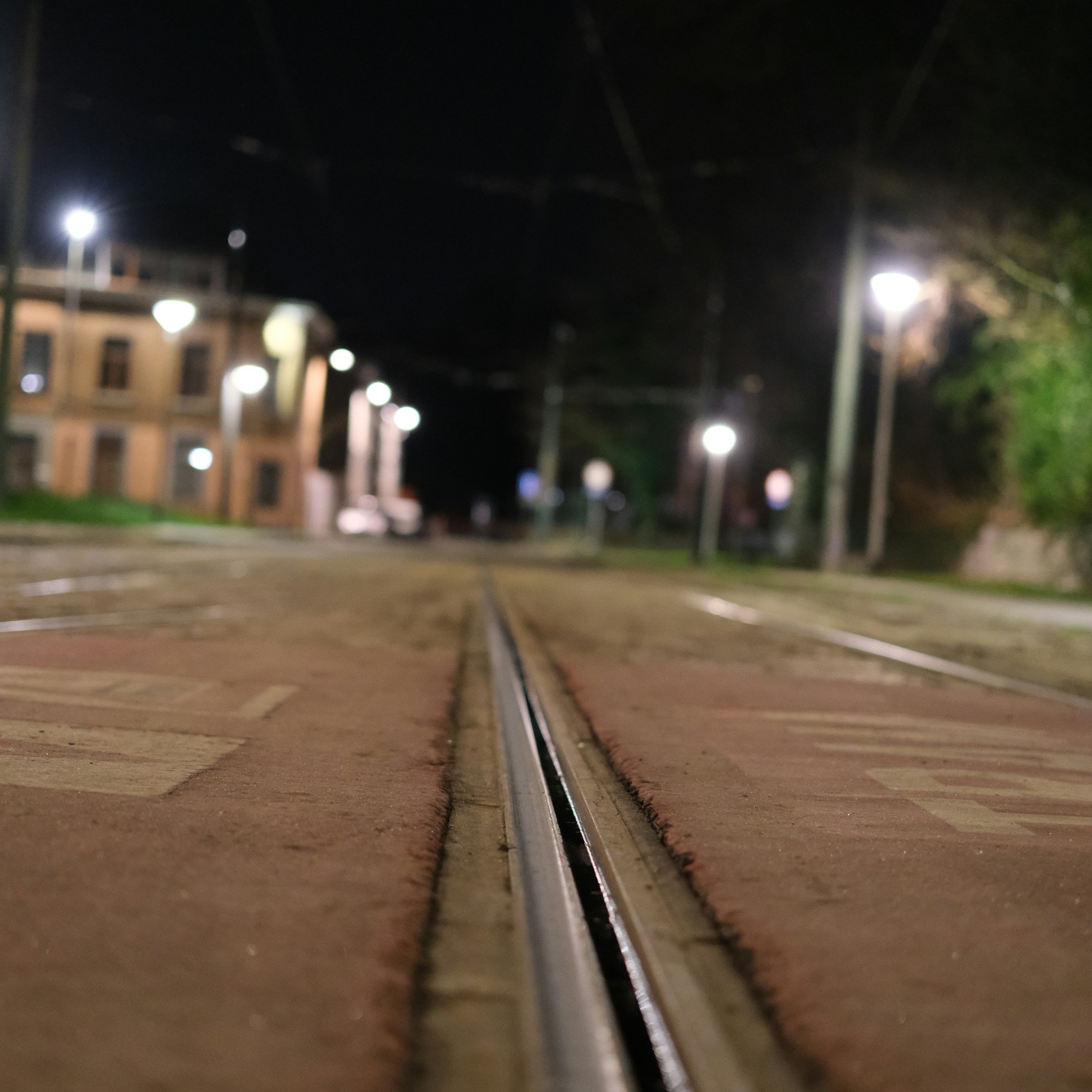 Midnight Convergence: Rails Fade Toward a Quiet Streetlight Horizon