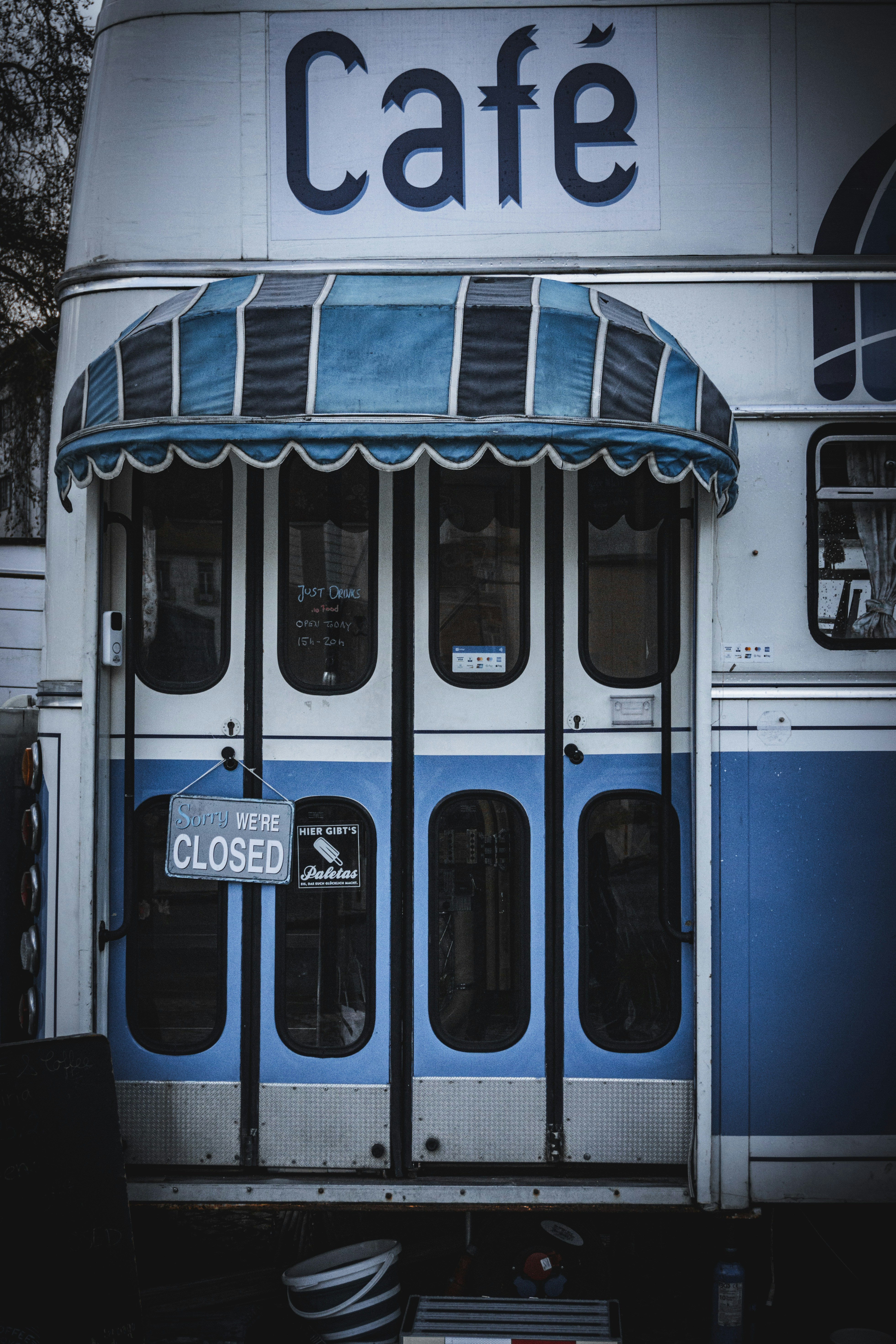 We’re Closed: A Vintage Blue-Diner Under a Striped Canopy