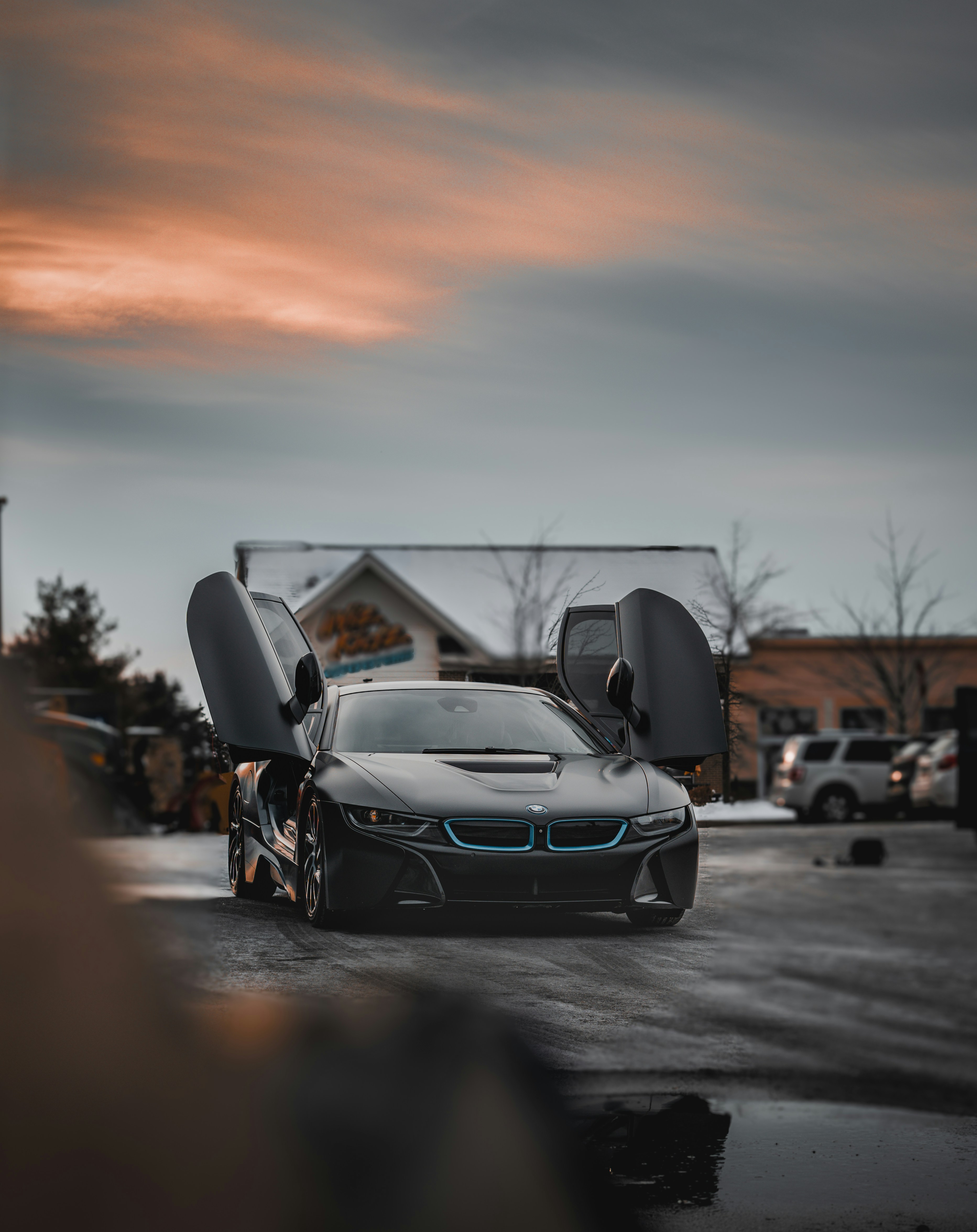 Dusk in the Winged Drive: BMW i8 with butterfly doors in a moody parking lot