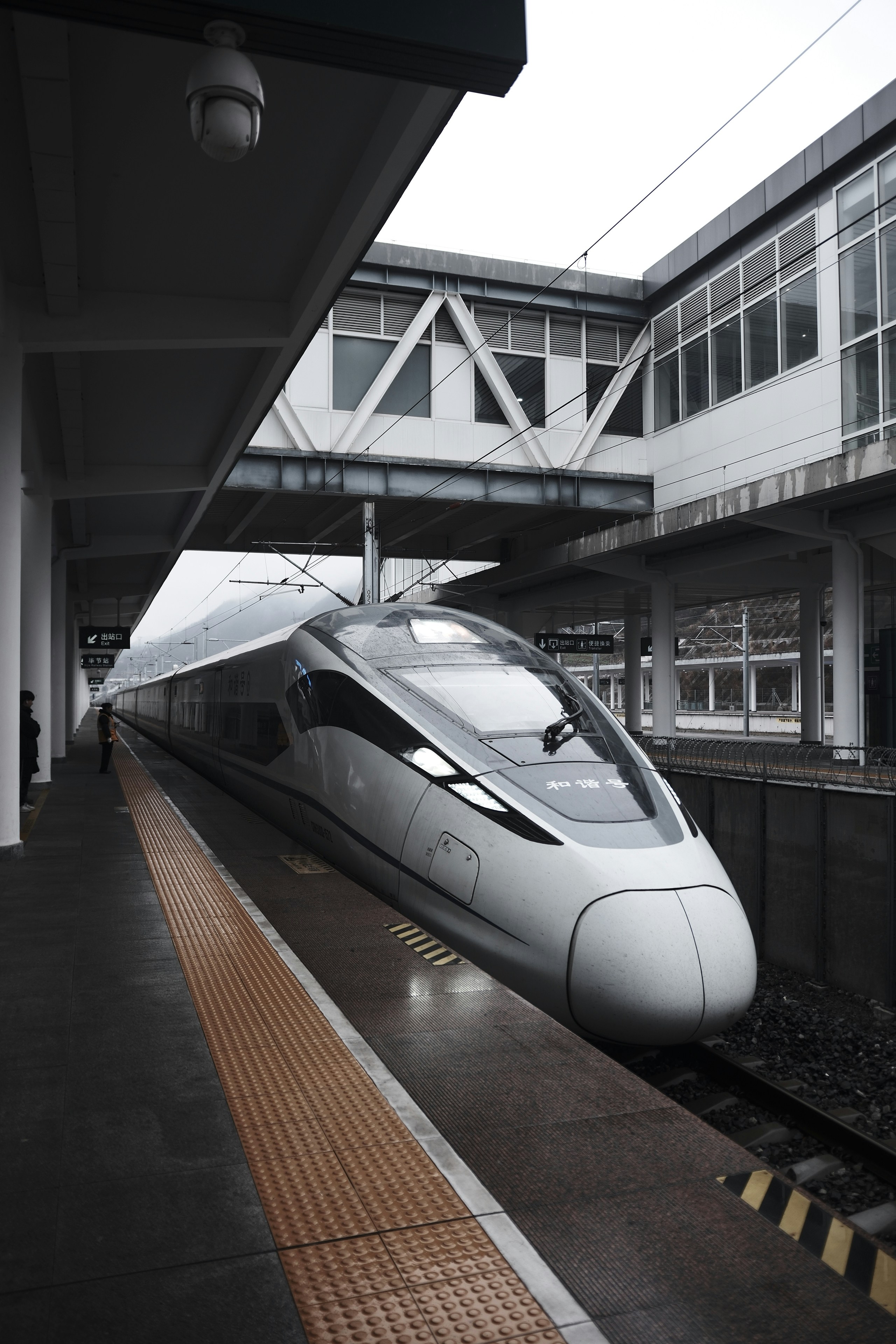 A silver bullet train pulling into a train station photo – Free High ...