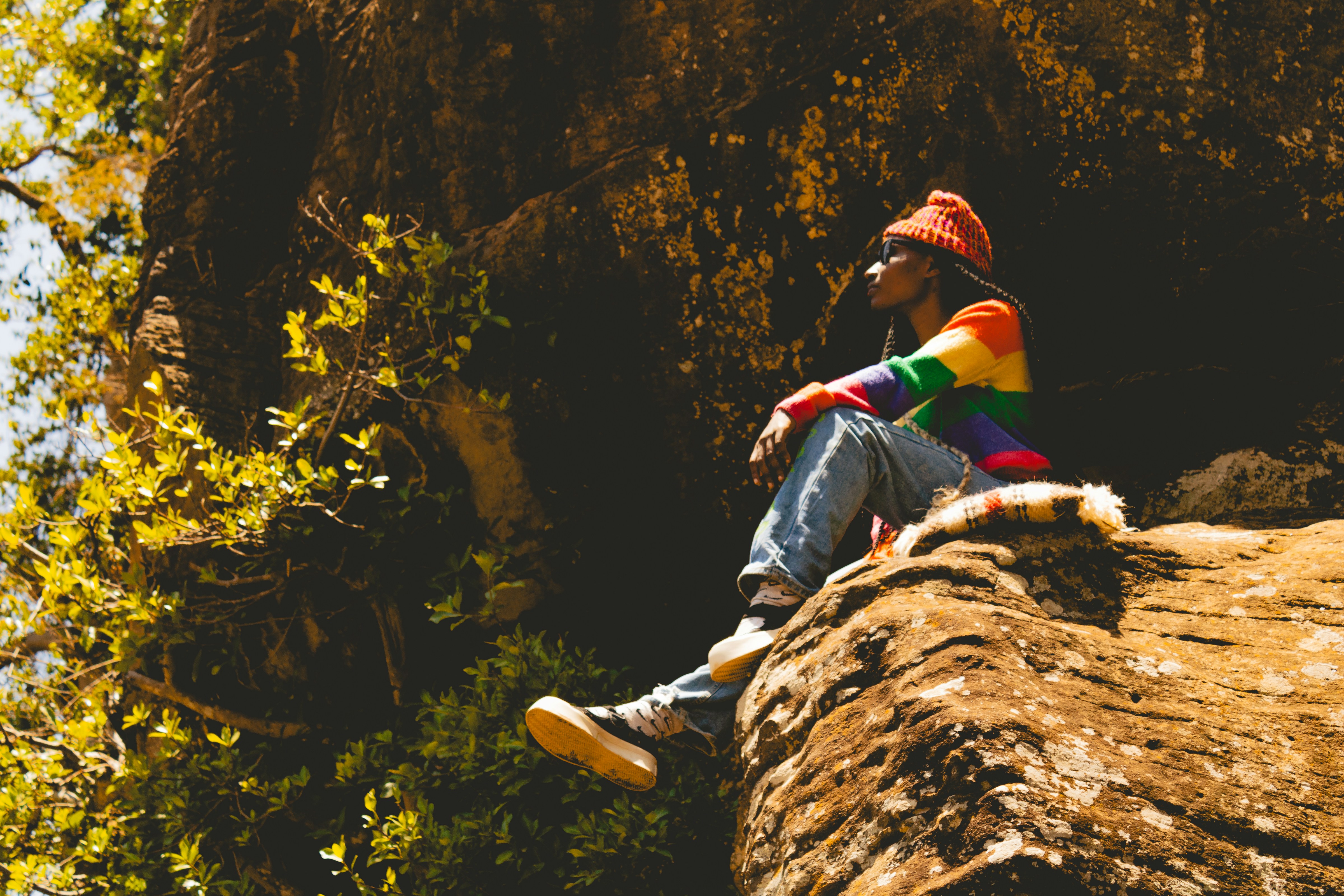 Ridgetop Quiet: Teen in Color on Sunlit Cliff