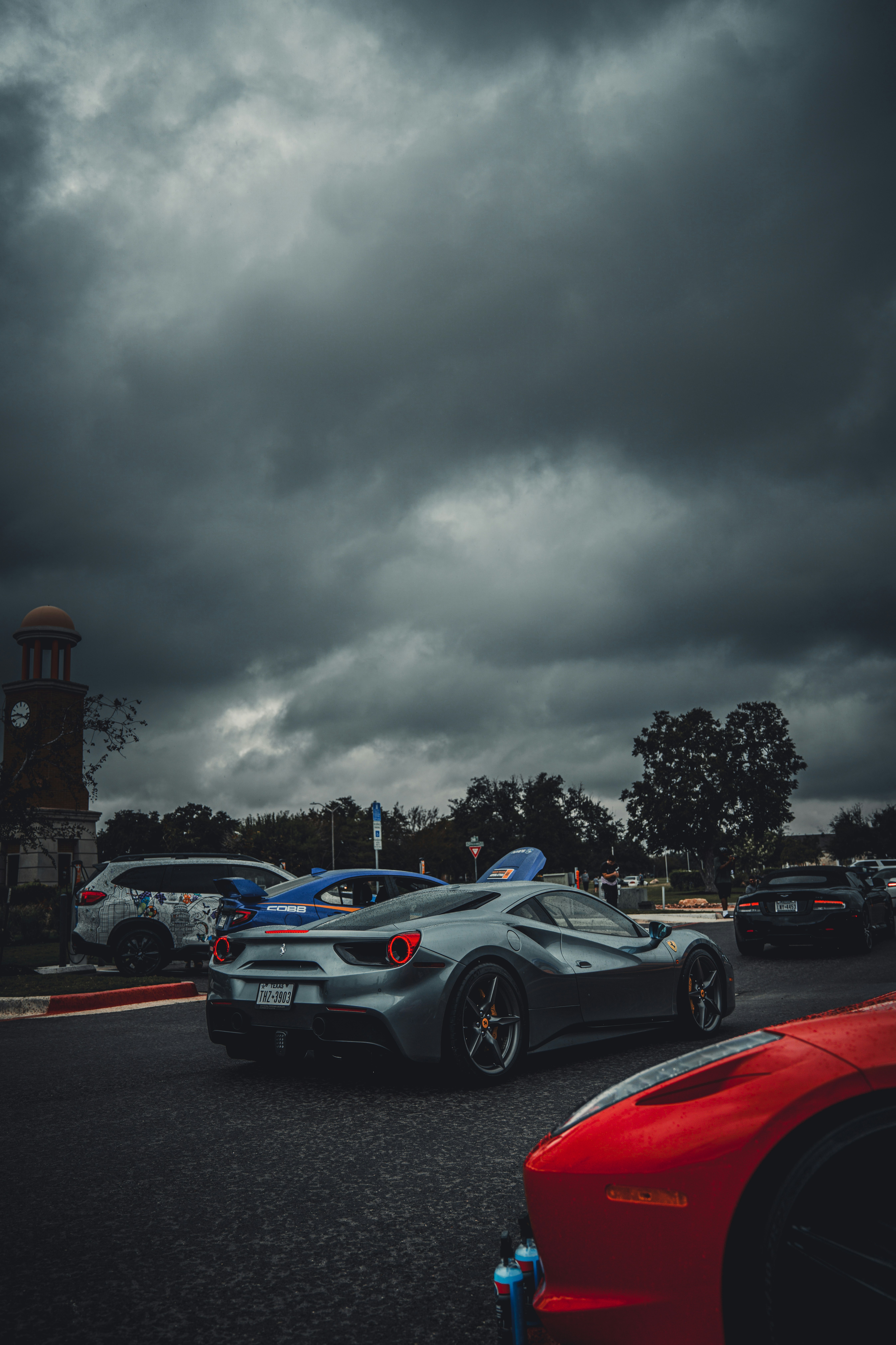 Brooding Sky Over a Silver Ferrari in a Storm-Lashed Parking Lot