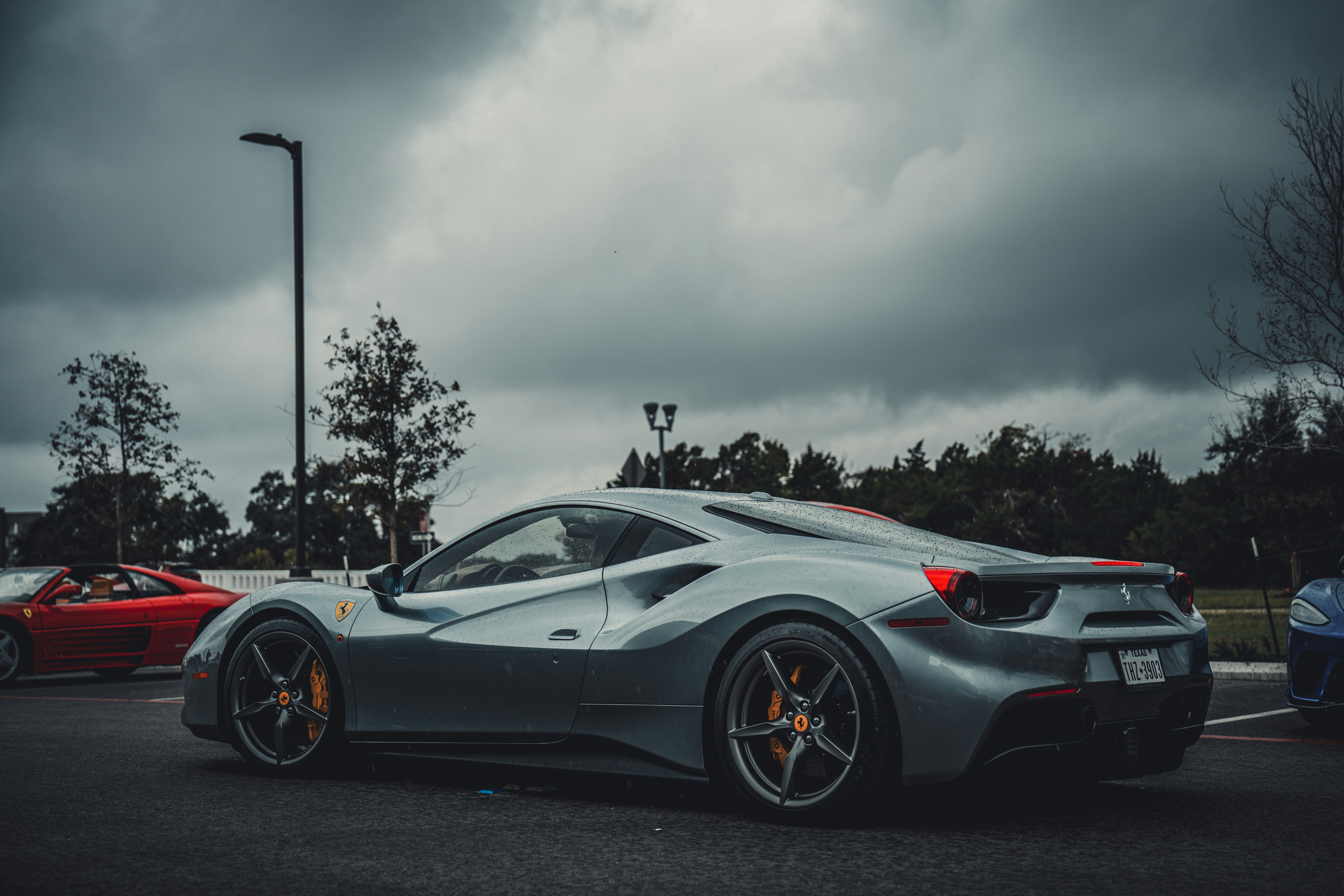 A silver sports car parked in a parking lot photo – Free Car Image on ...