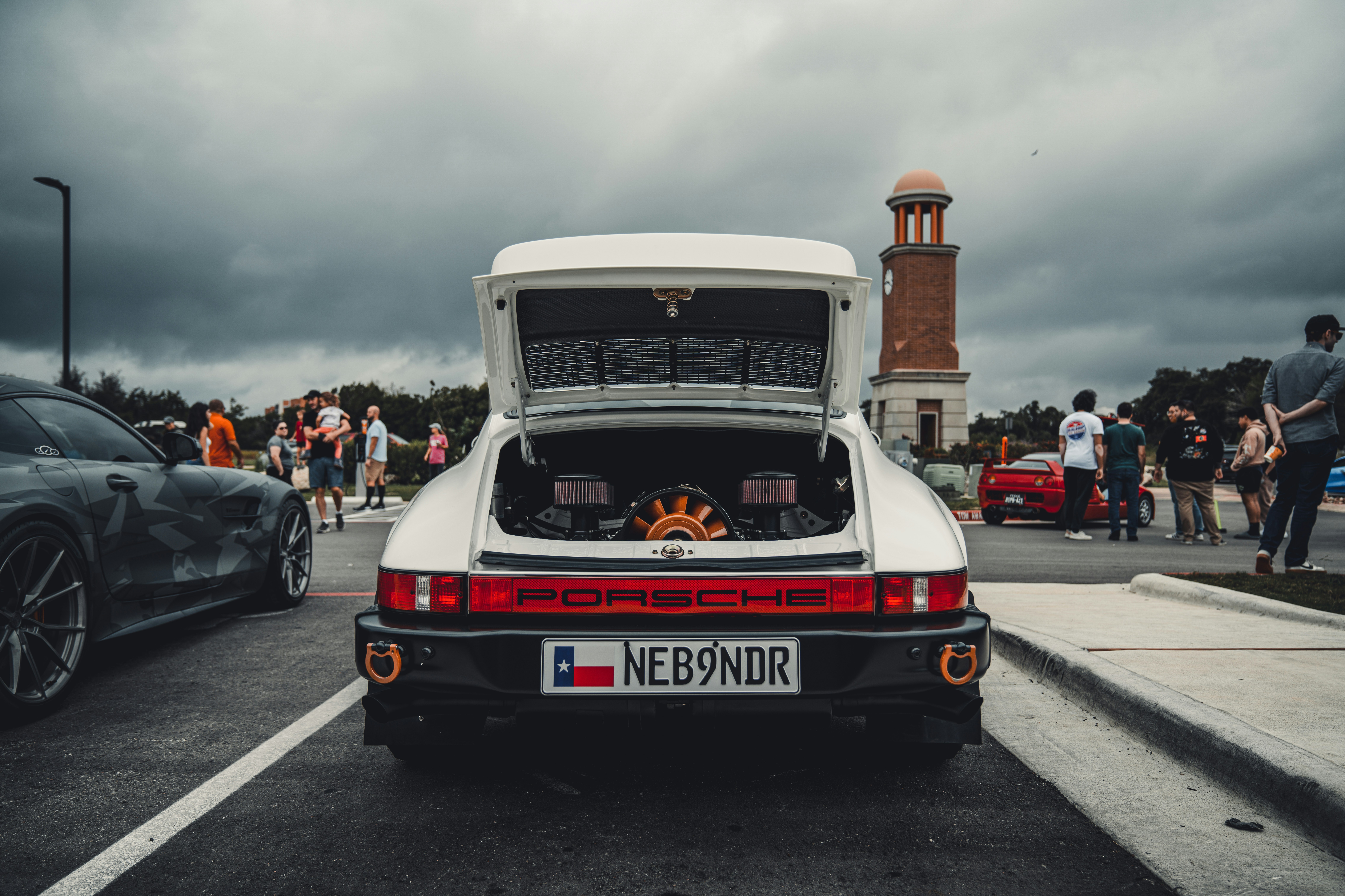 Open Trunk, Quiet Spotlight: A Porsche at the Crowd
