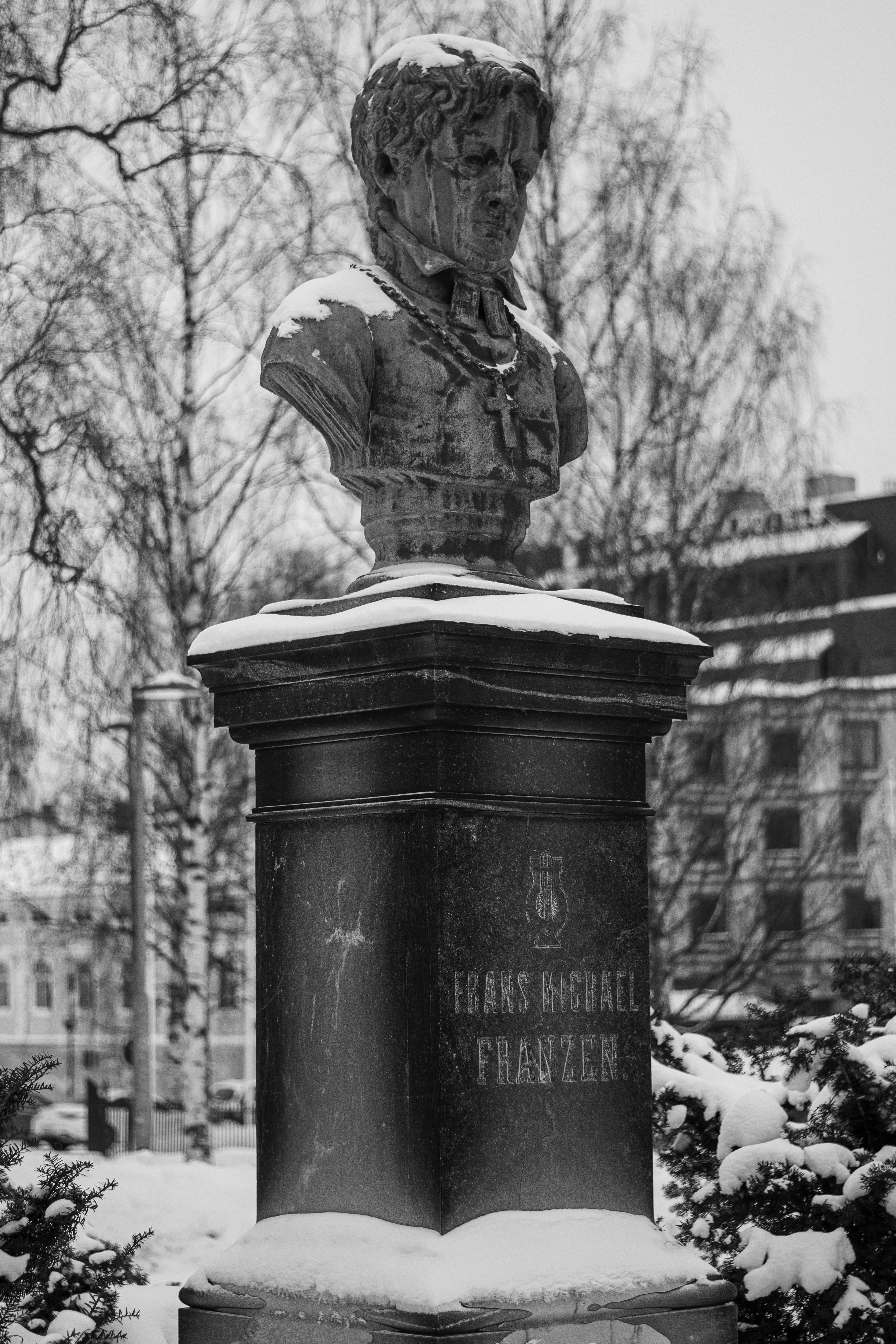 Snowbound Bust in a Winter-Quiet City Square