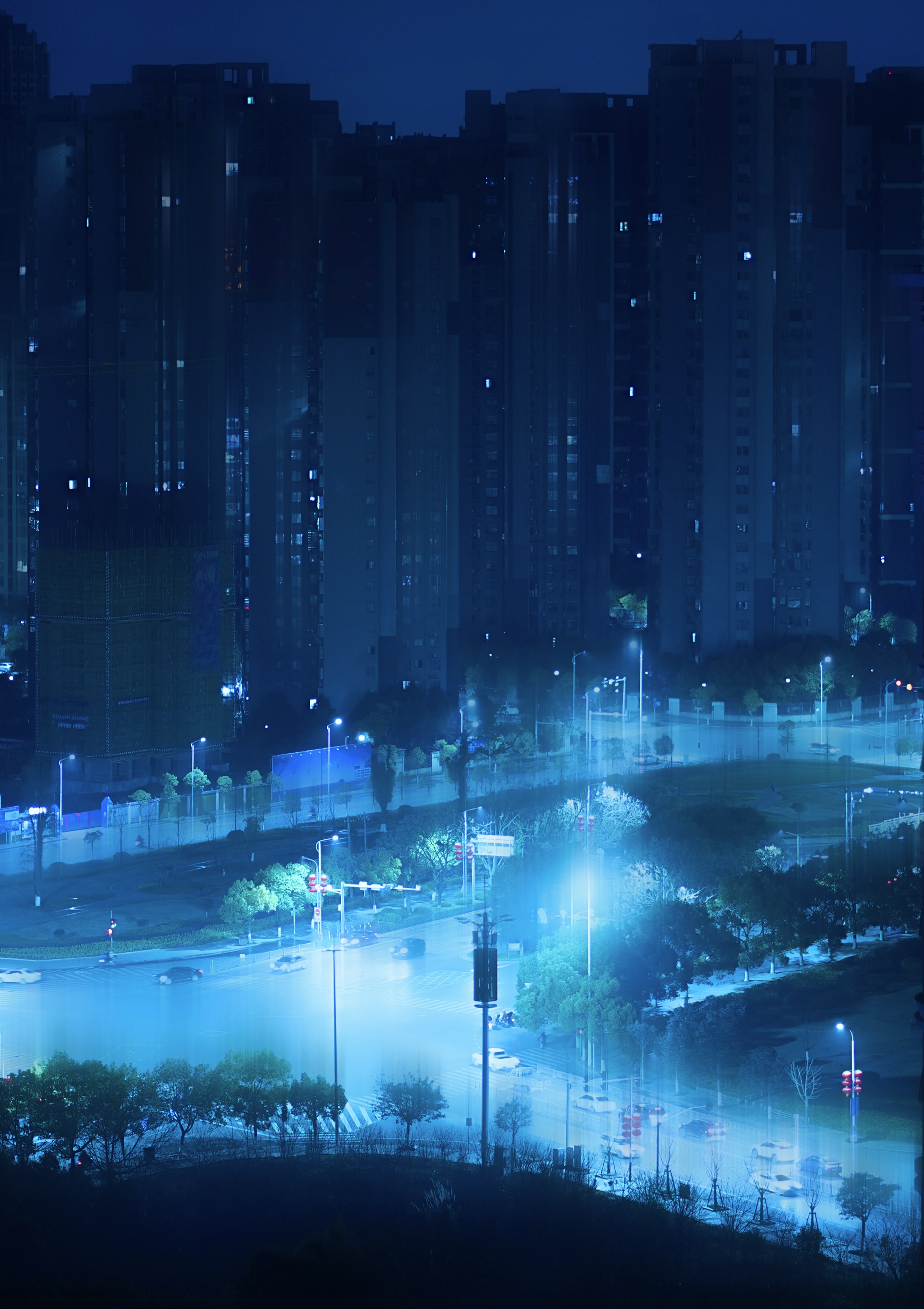 Cobalt Nightfall: Neon Mist Along a Quiet Boulevard Framed by Towering Silhouettes