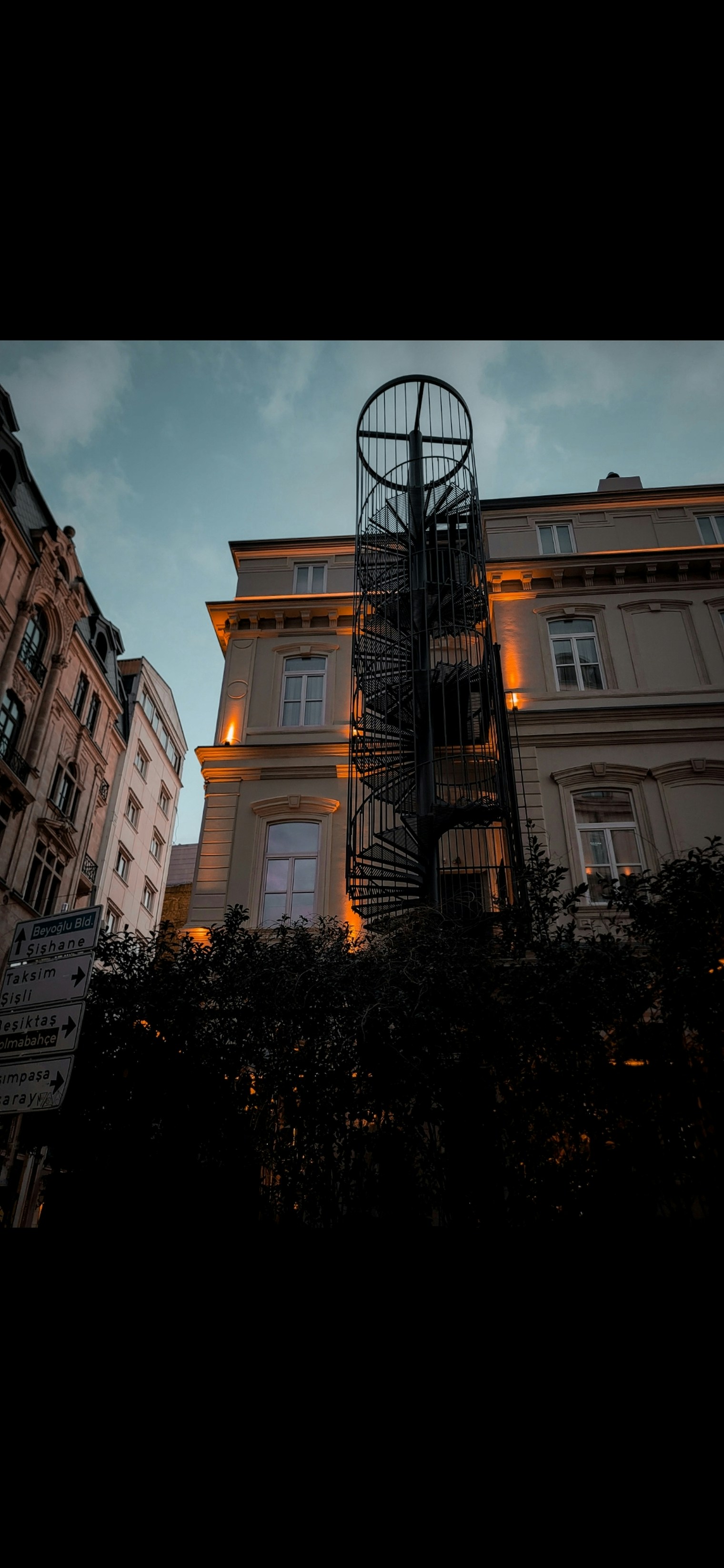 A tall building with a fire escape next to it photo – Free Building ...