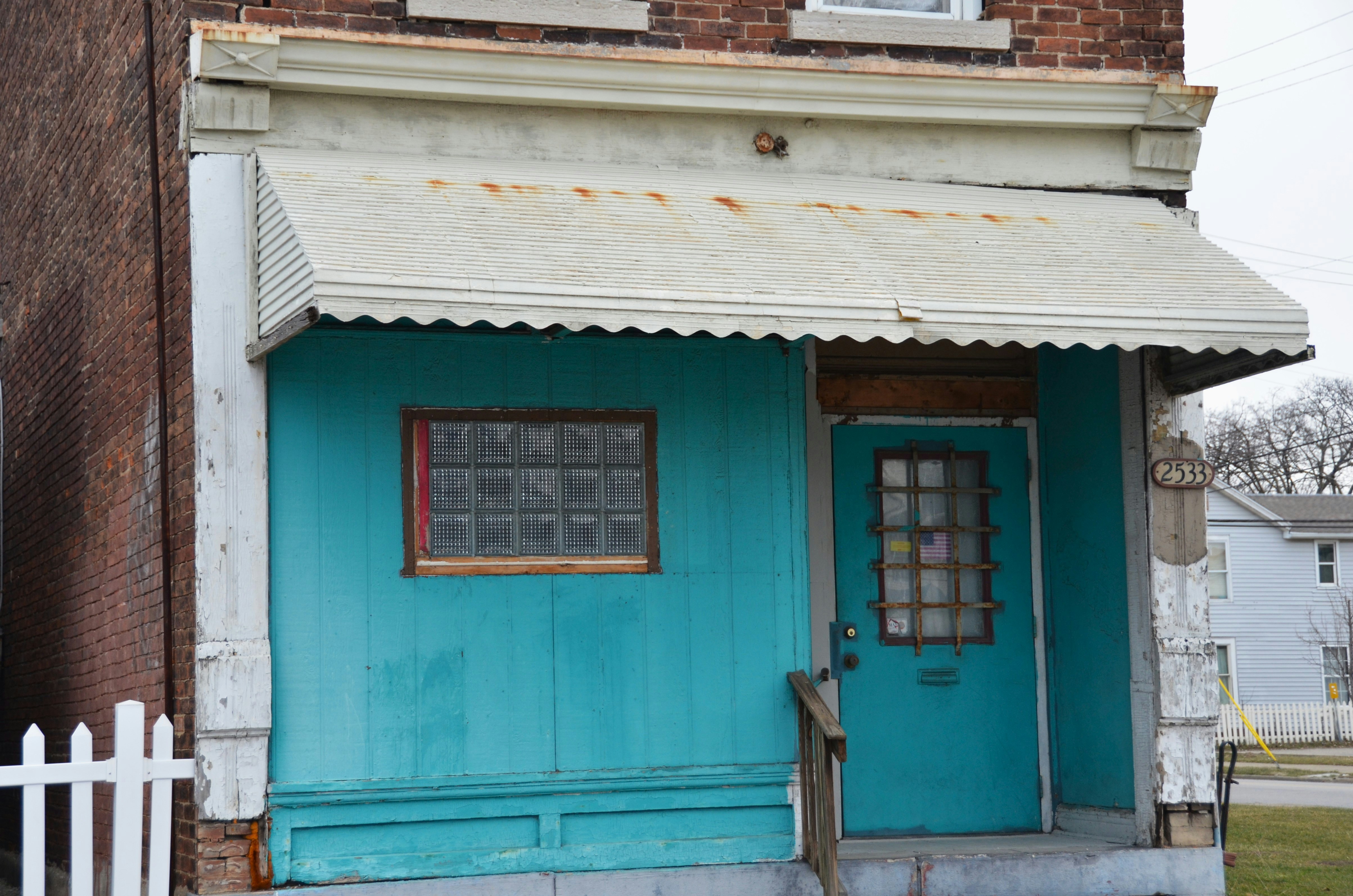A small blue building with a white awning photo – Free Blue Image on ...