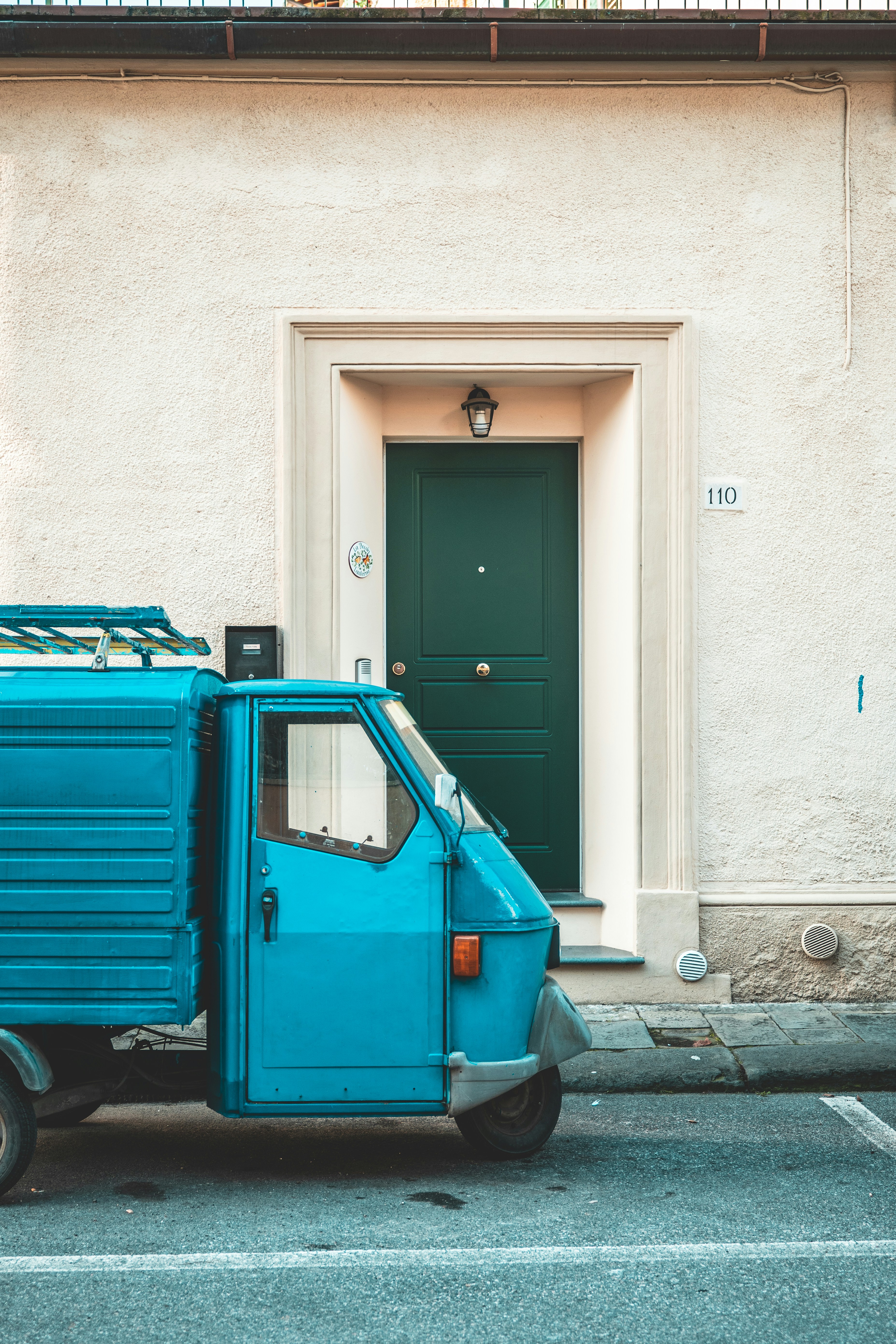 Azure Van Before a Verdant Doorway