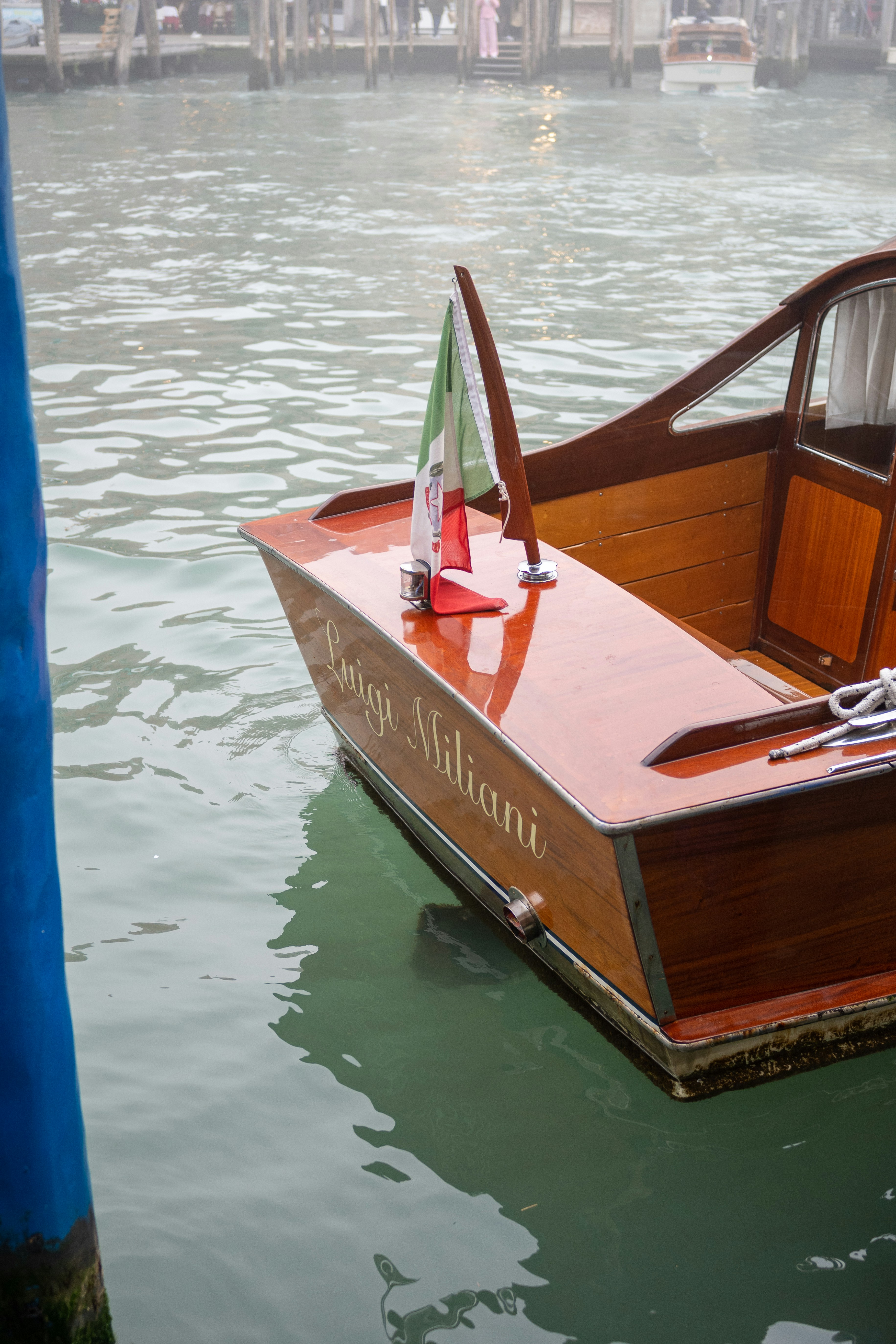 Teak and Tricolor at the Dock: A Quiet Canal Moment