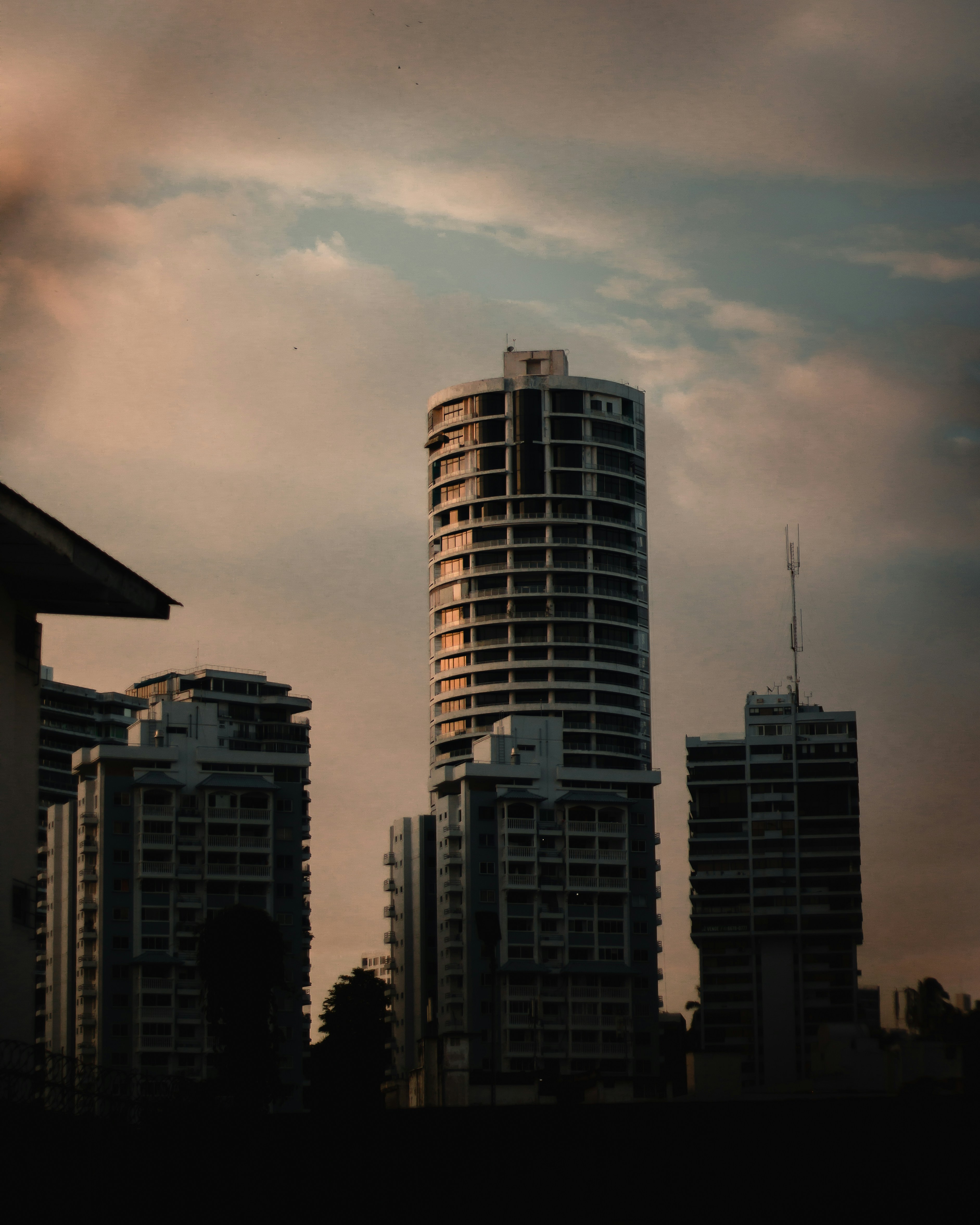 Dusk Sentinel: The Ringed Tower Rising Over a Quiet Cityscape