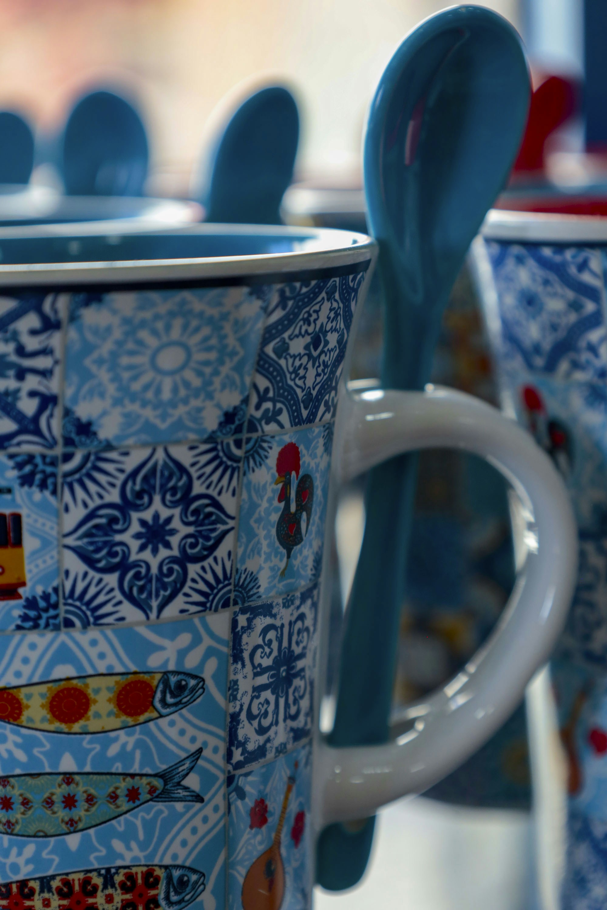 Blue Tile Reverie: A Close-Up of Patterned Mugs and a Turquoise Spoon