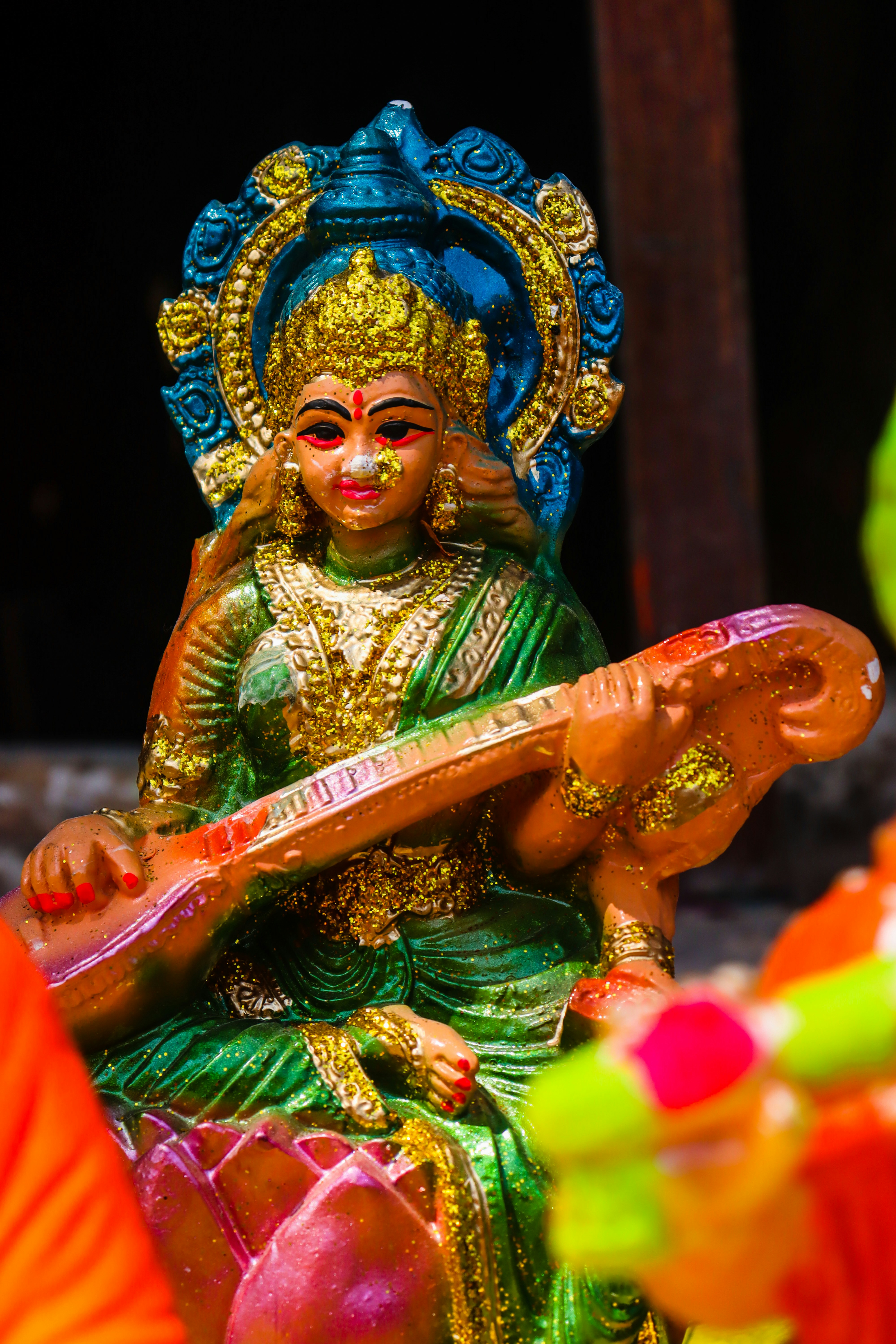 Veena-Wielding Goddess: a Turquoise-Gold Statue in Electric Color