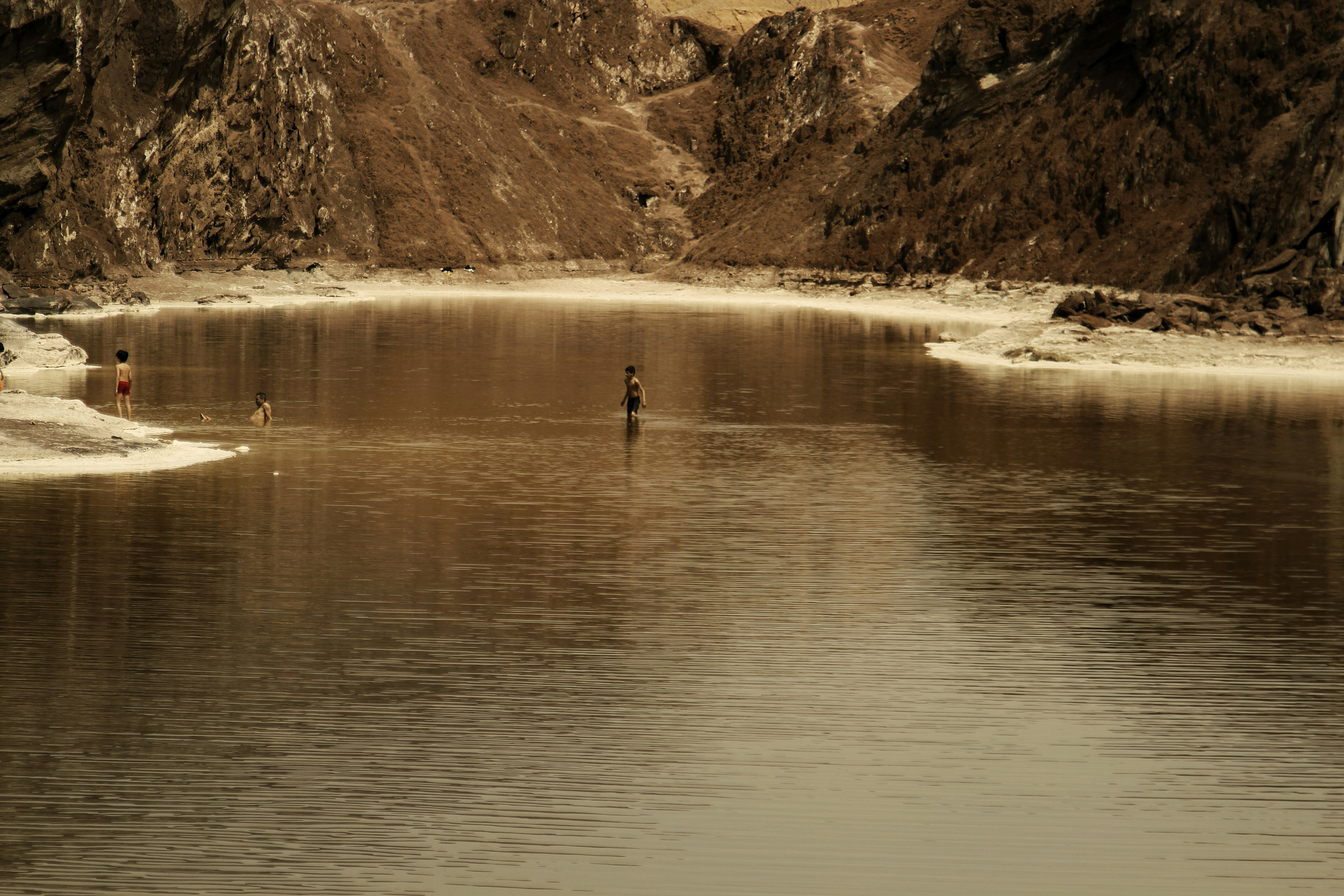 A group of people wading in a body of water photo – Free Landscape ...