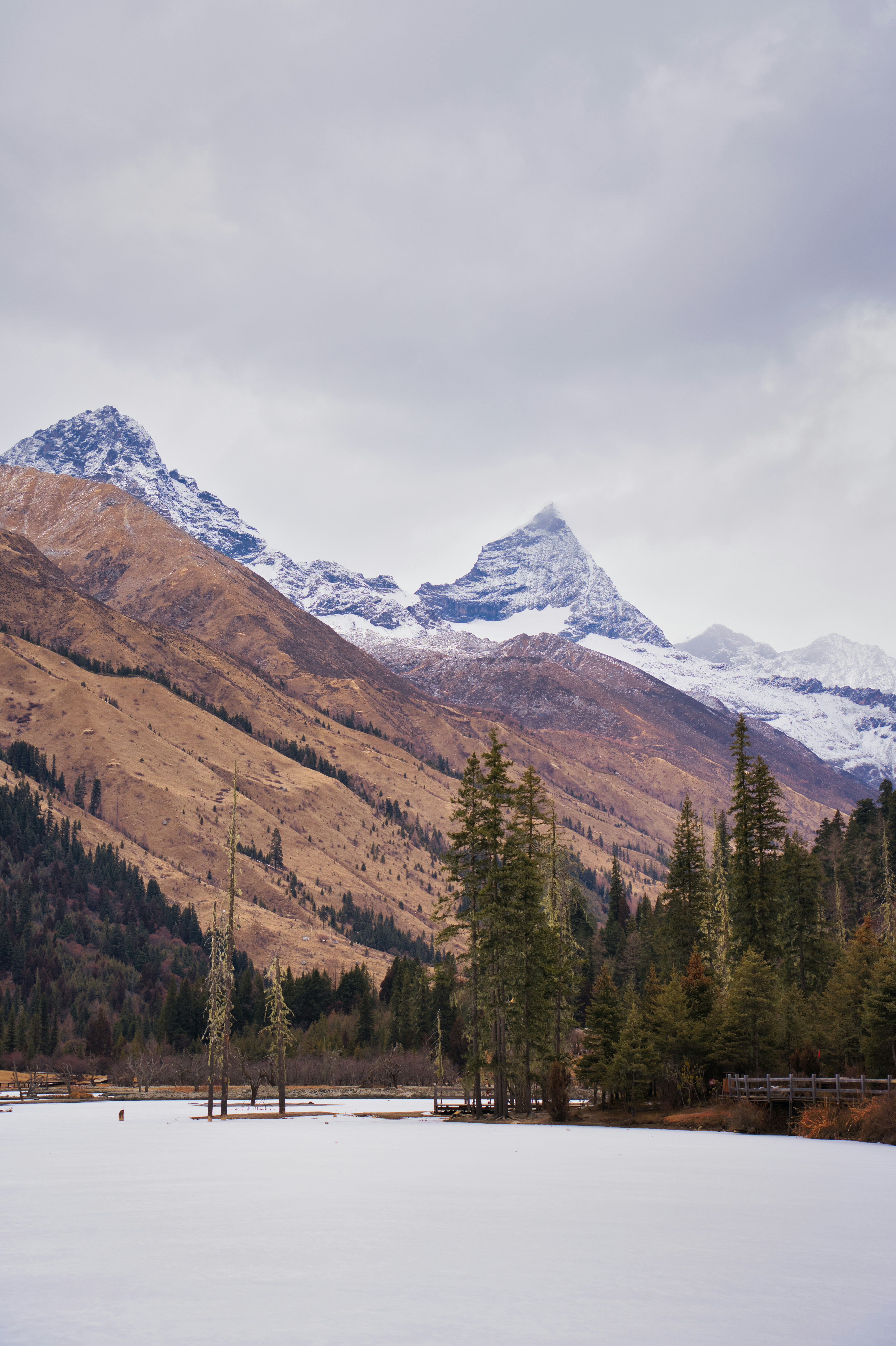 Snow-kissed Peaks Over a Quiet Icy Lake