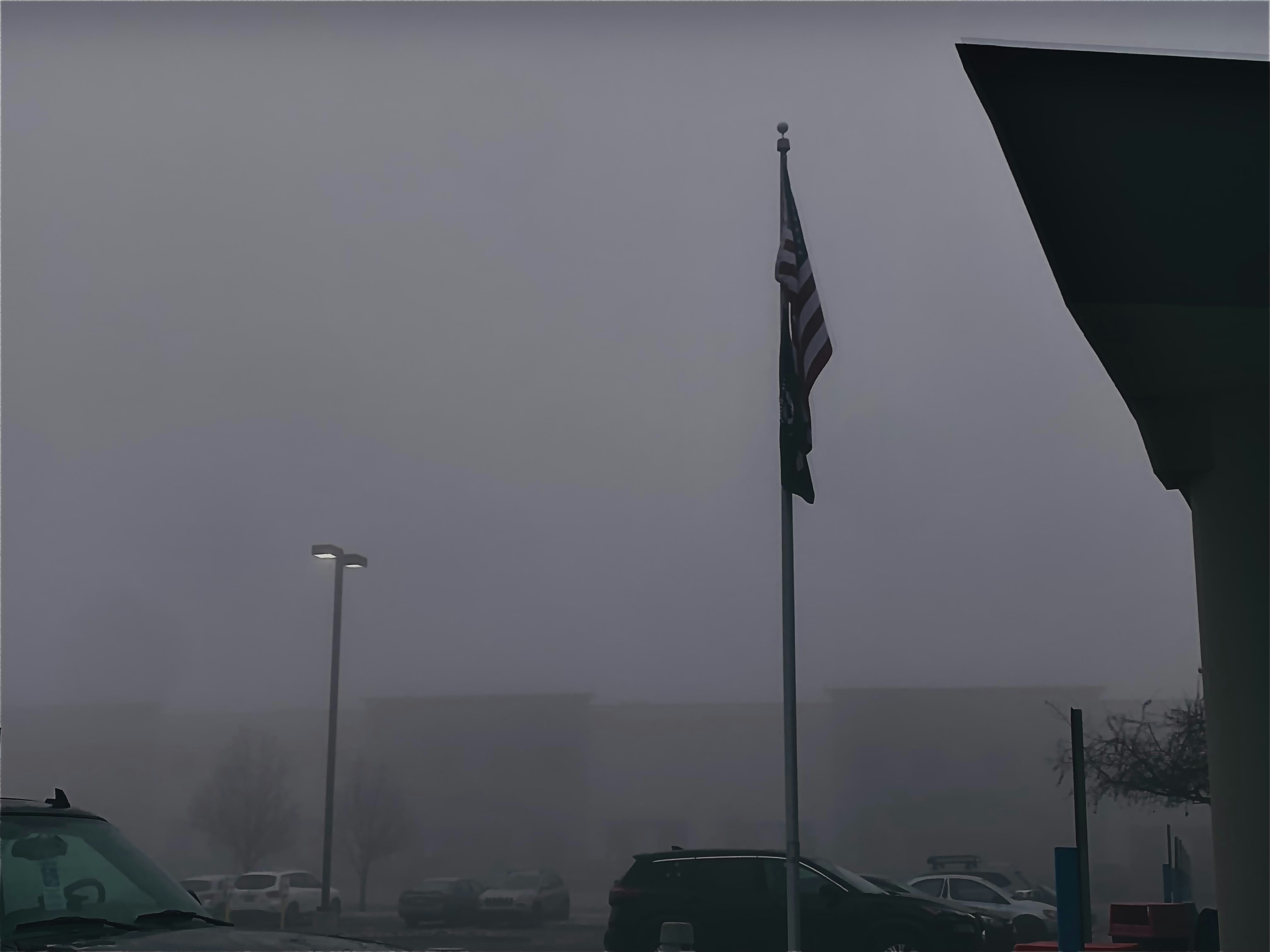 Low-Visibility Gate: Foggy Parking Lot at Dusk