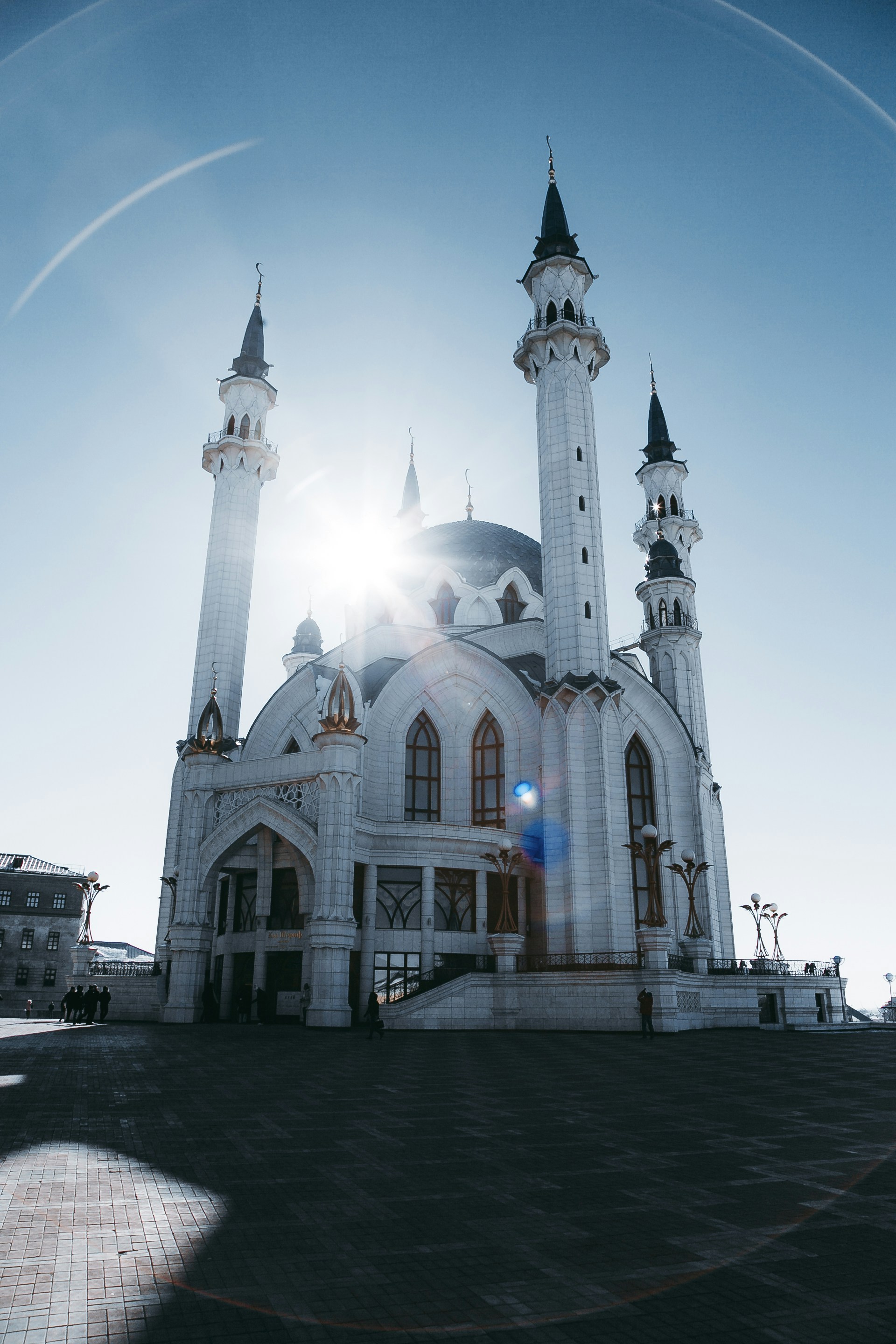 Sunburst Over the Marble Mosque: Four Minarets Against a Clear Blue Sky