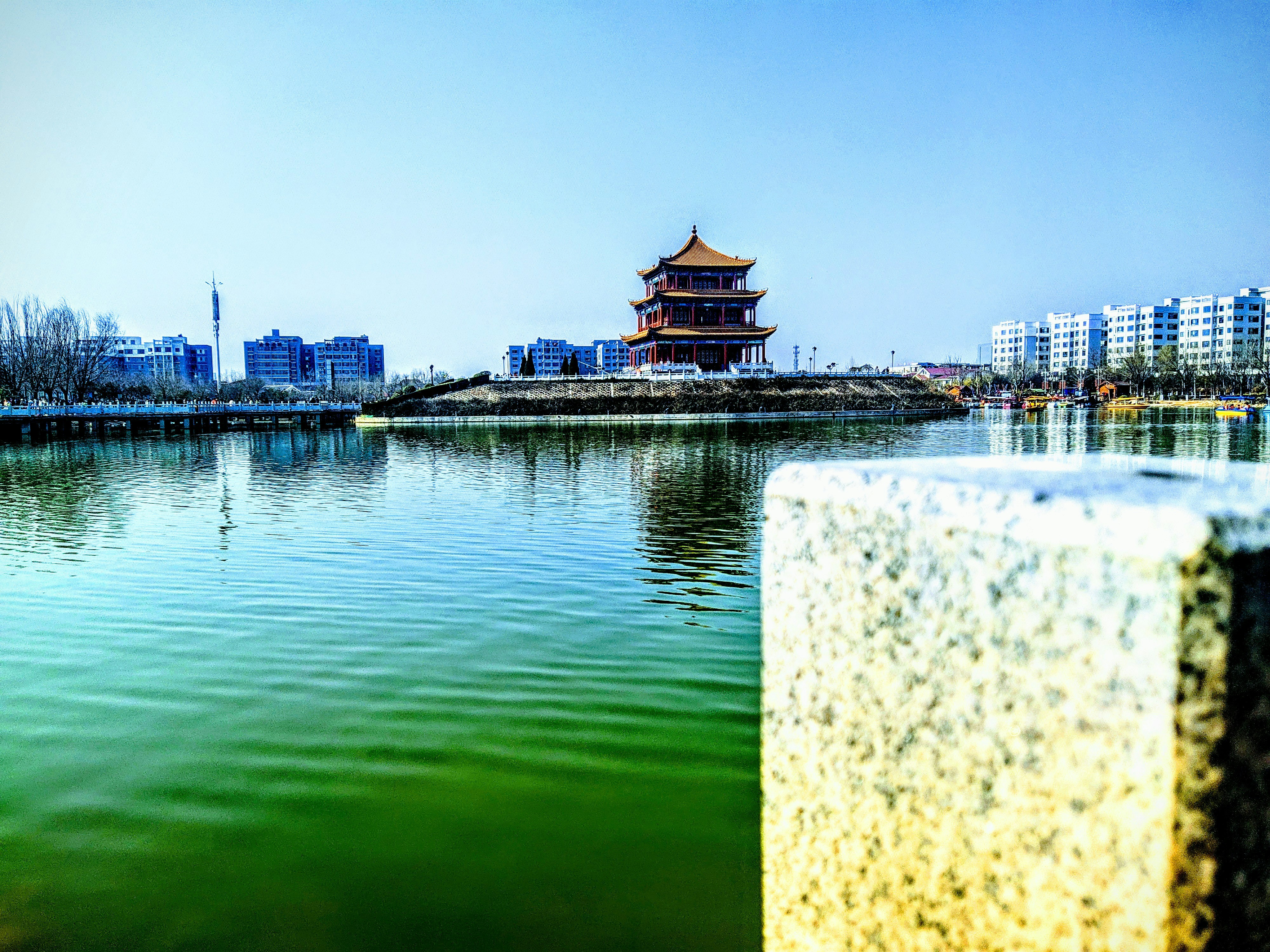 Pagoda Island on a Green-Tinted Lake: Urban Silence Across Water